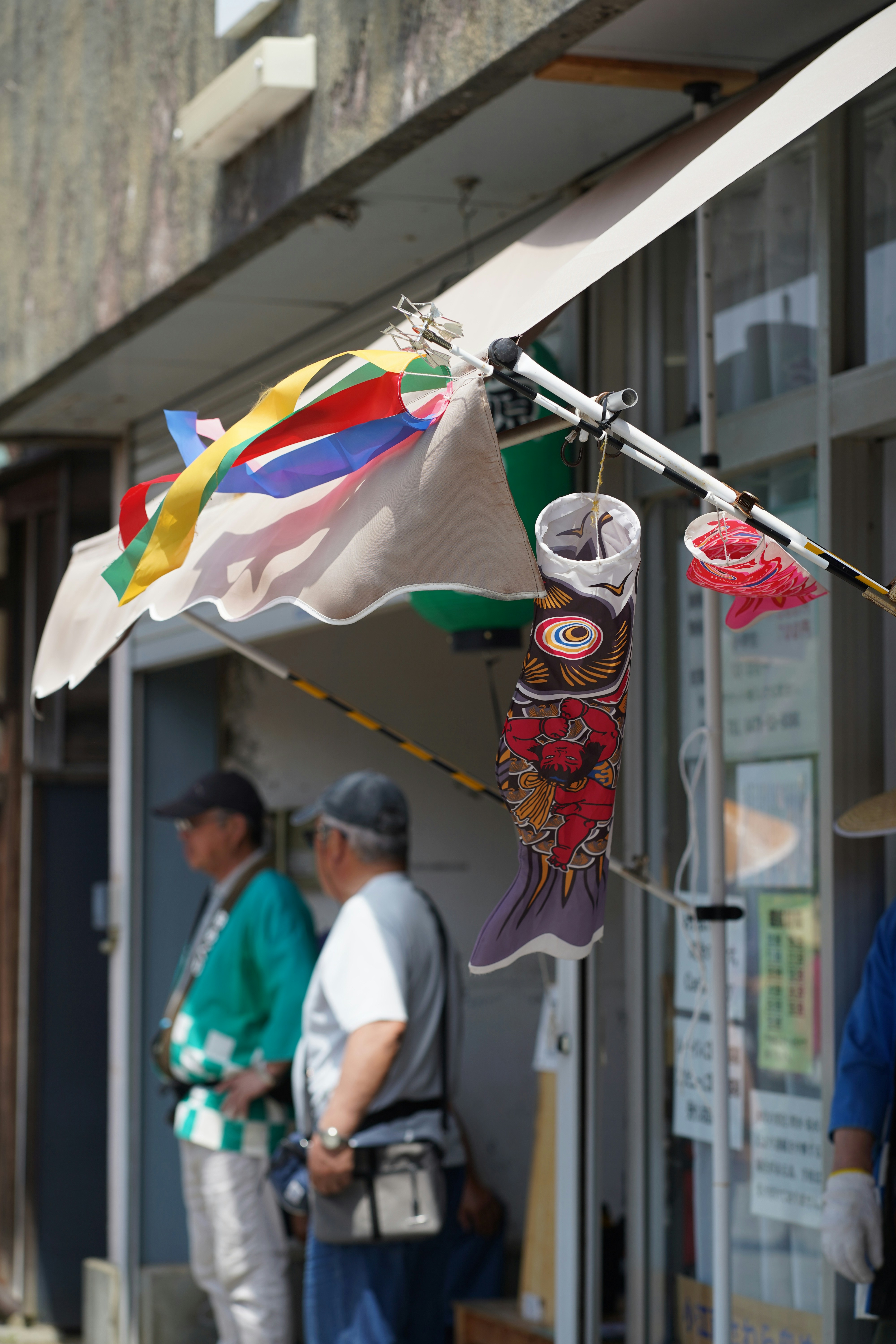 Colorful winds and street life: banners flutter above a doorway