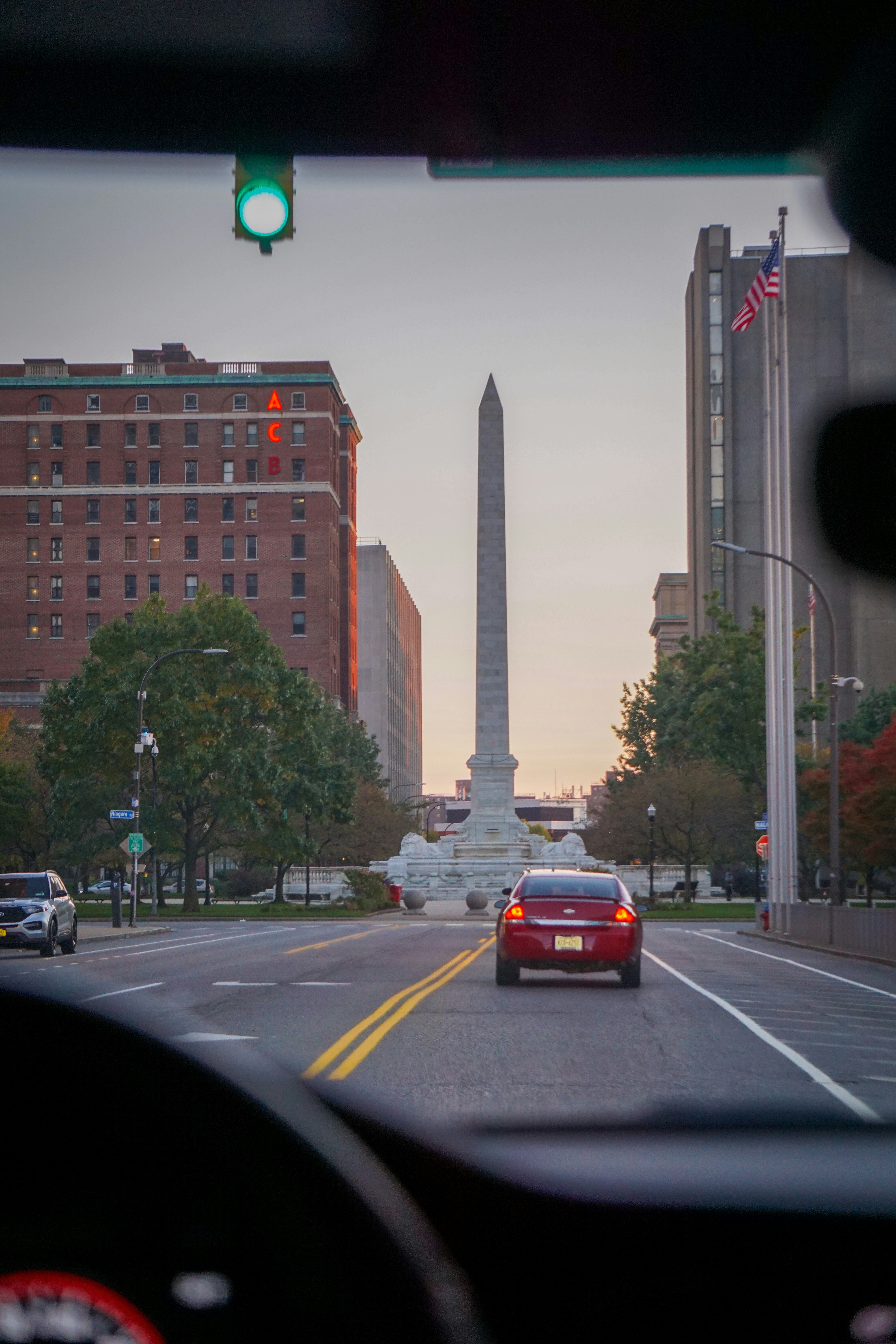 Aspiration in Stone: An Obelisk Framed by City Traffic