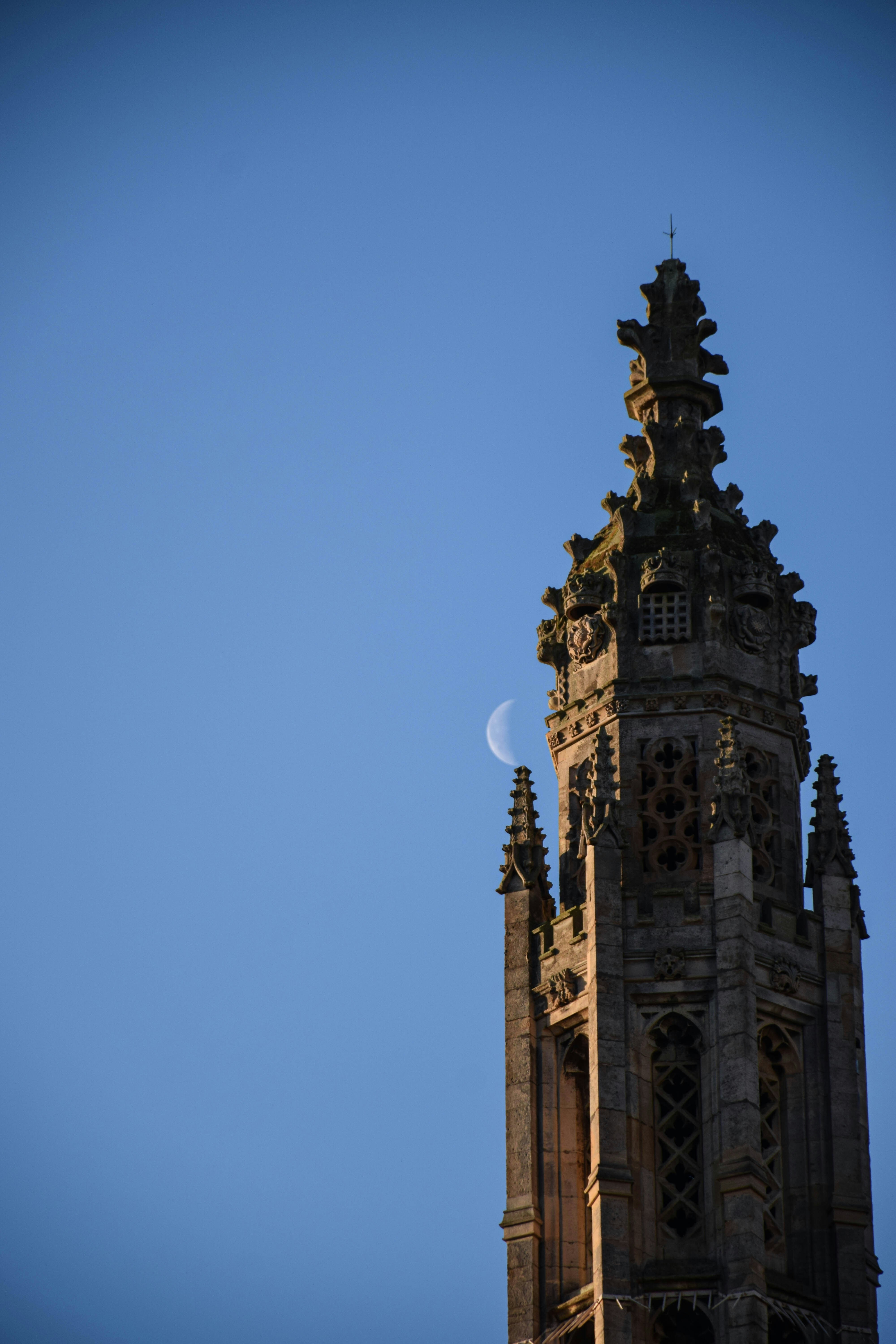 Moonlit Spire: A Gothic Tower Reaching into Clear Evening Sky