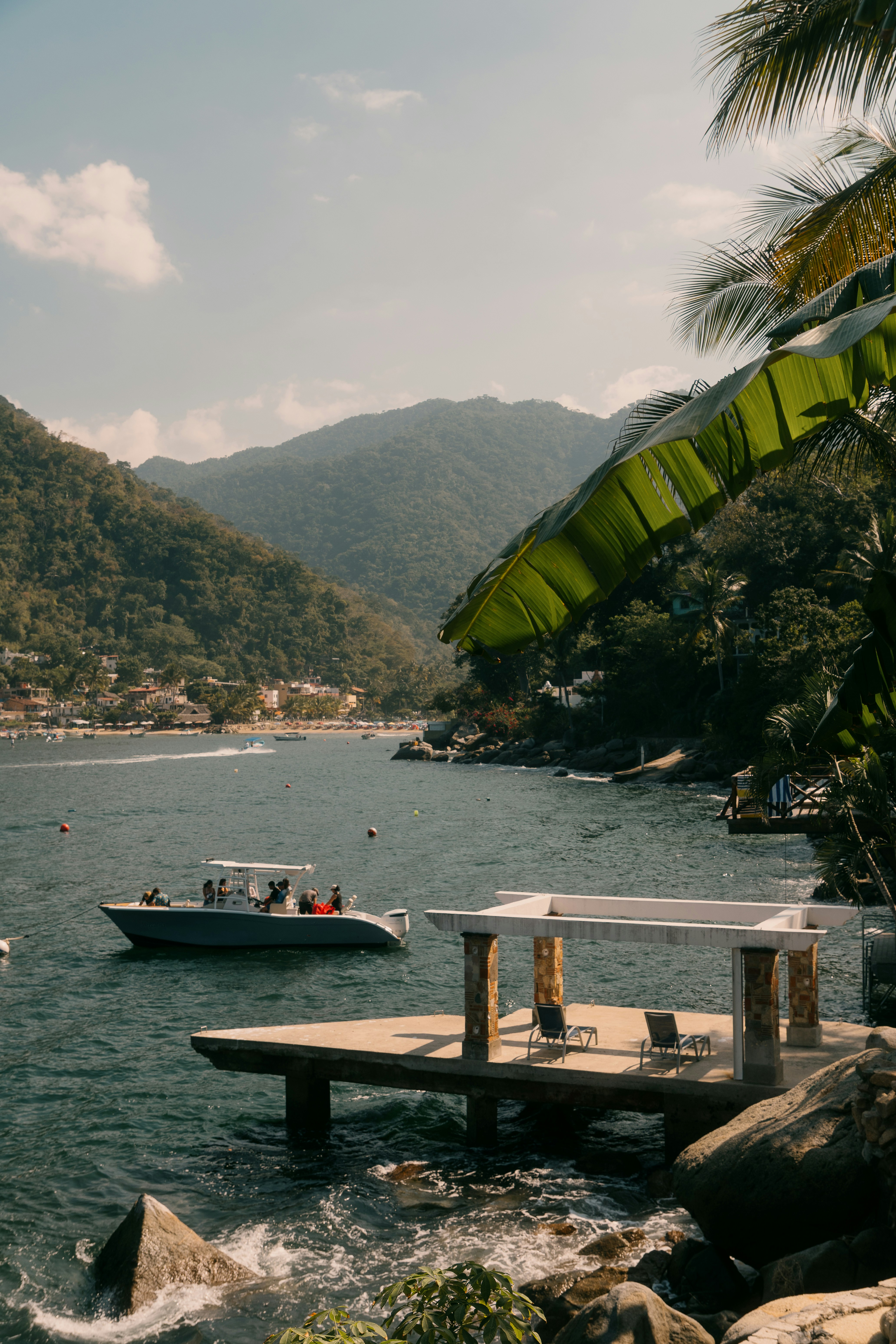 Sunlit Jetty Over Crystal Waters Amid Tropical Hills