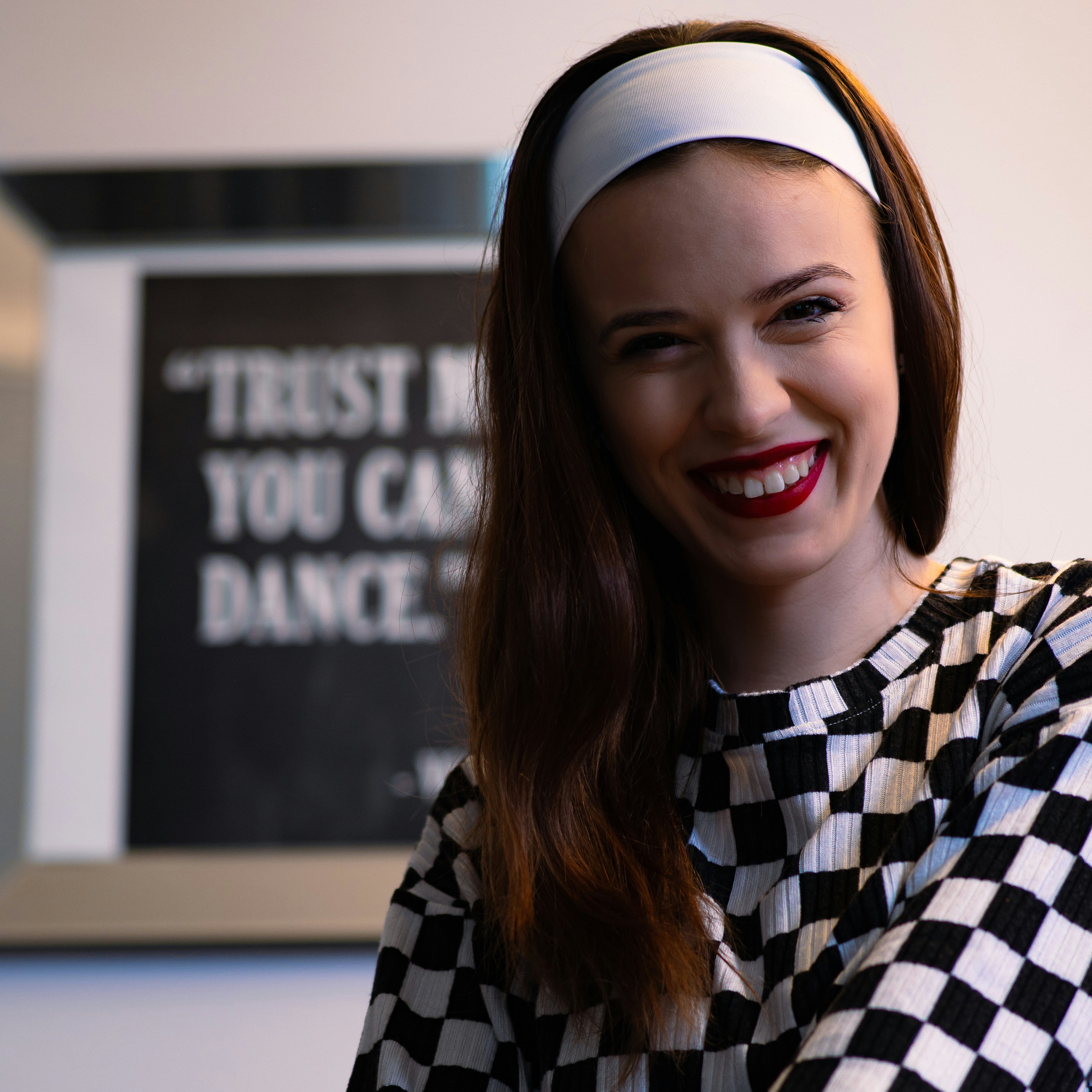 Smiling Confidence in a Checkerboard Moment