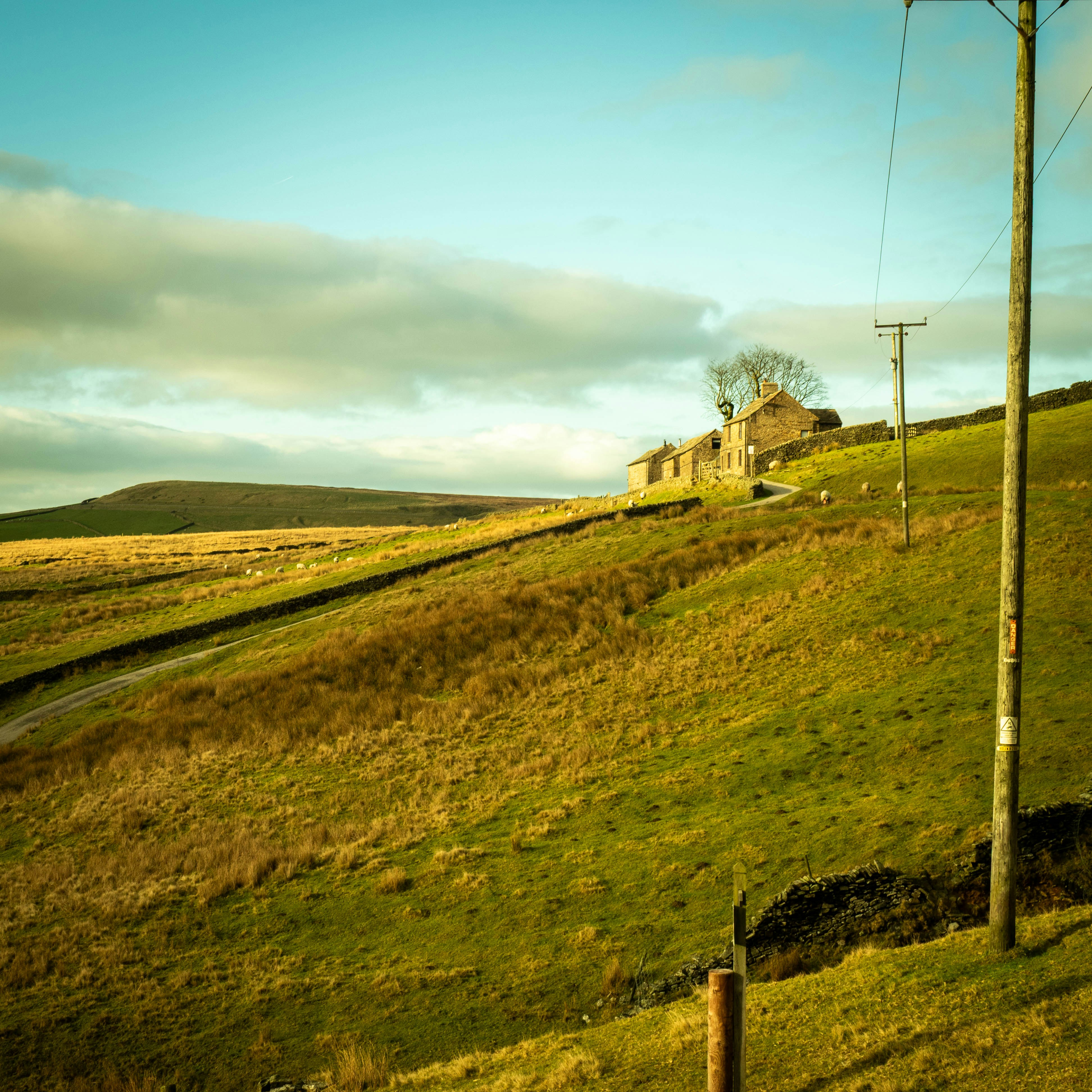 Rural Hilltop House Under a Wide Sky
