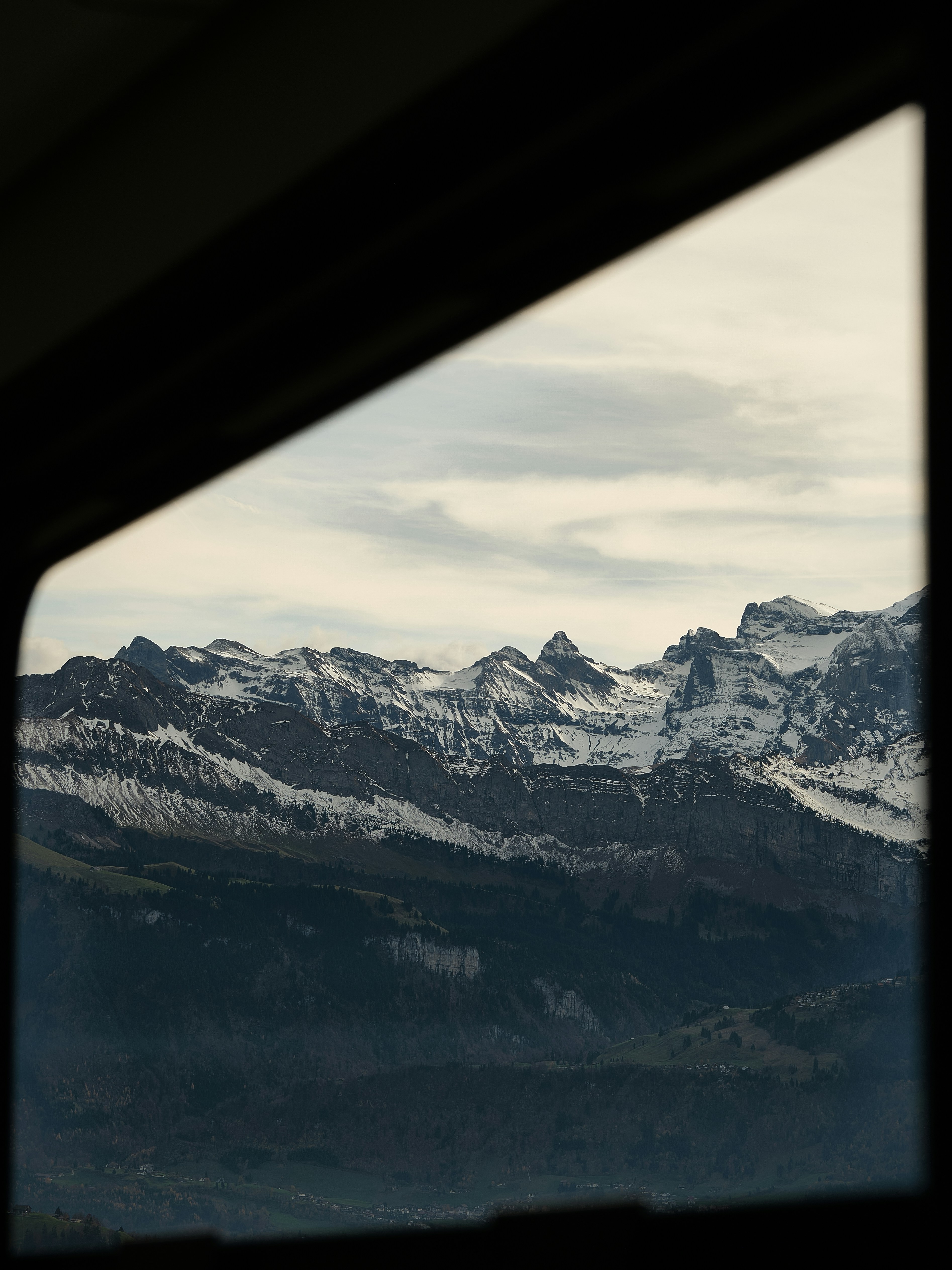 Snow-capped Ridge Framed by Window Edge