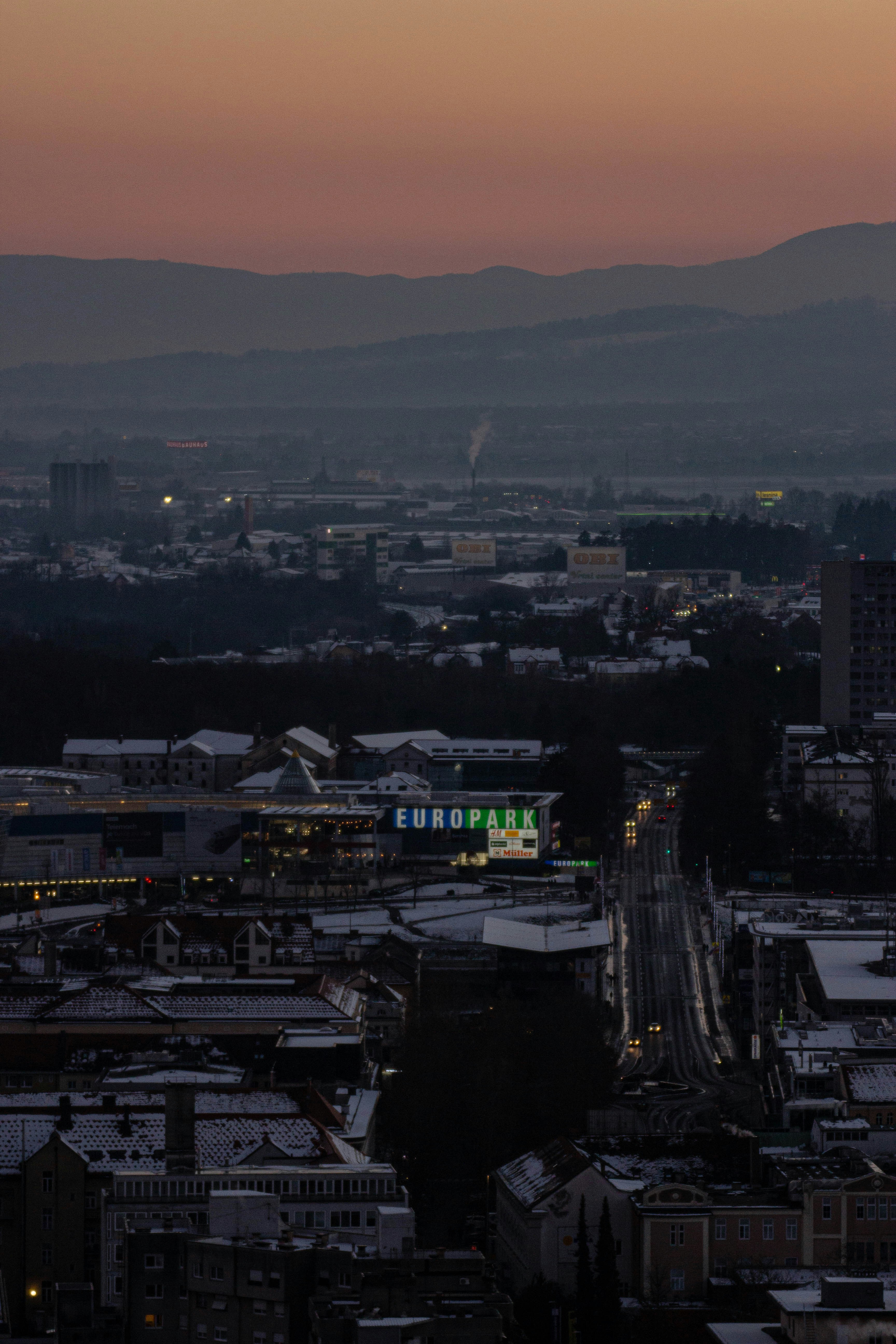 Evening Glow Over Europark: Neon Signway into a Quiet City