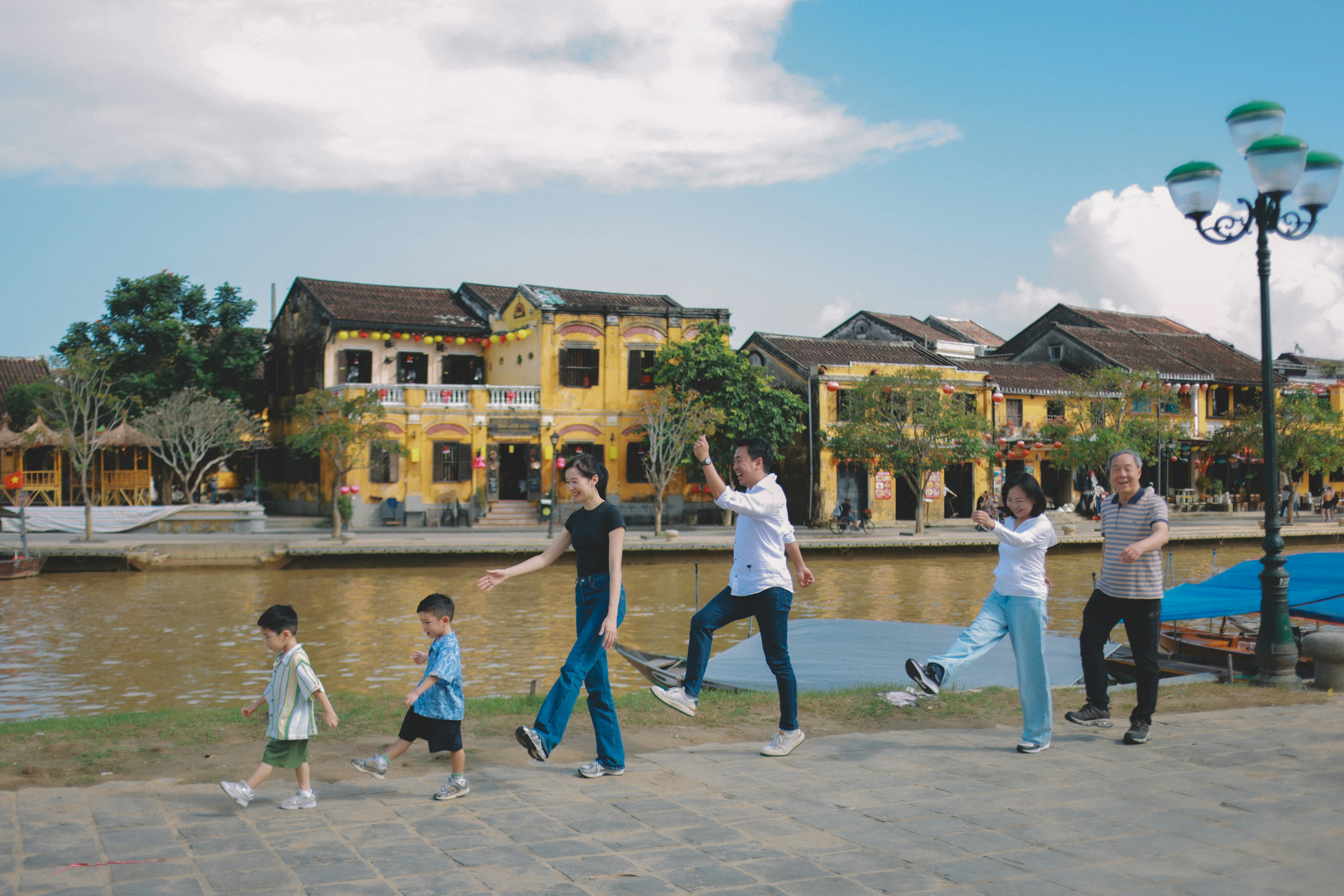 Leisure Parade Along a Sunlit Canal Front