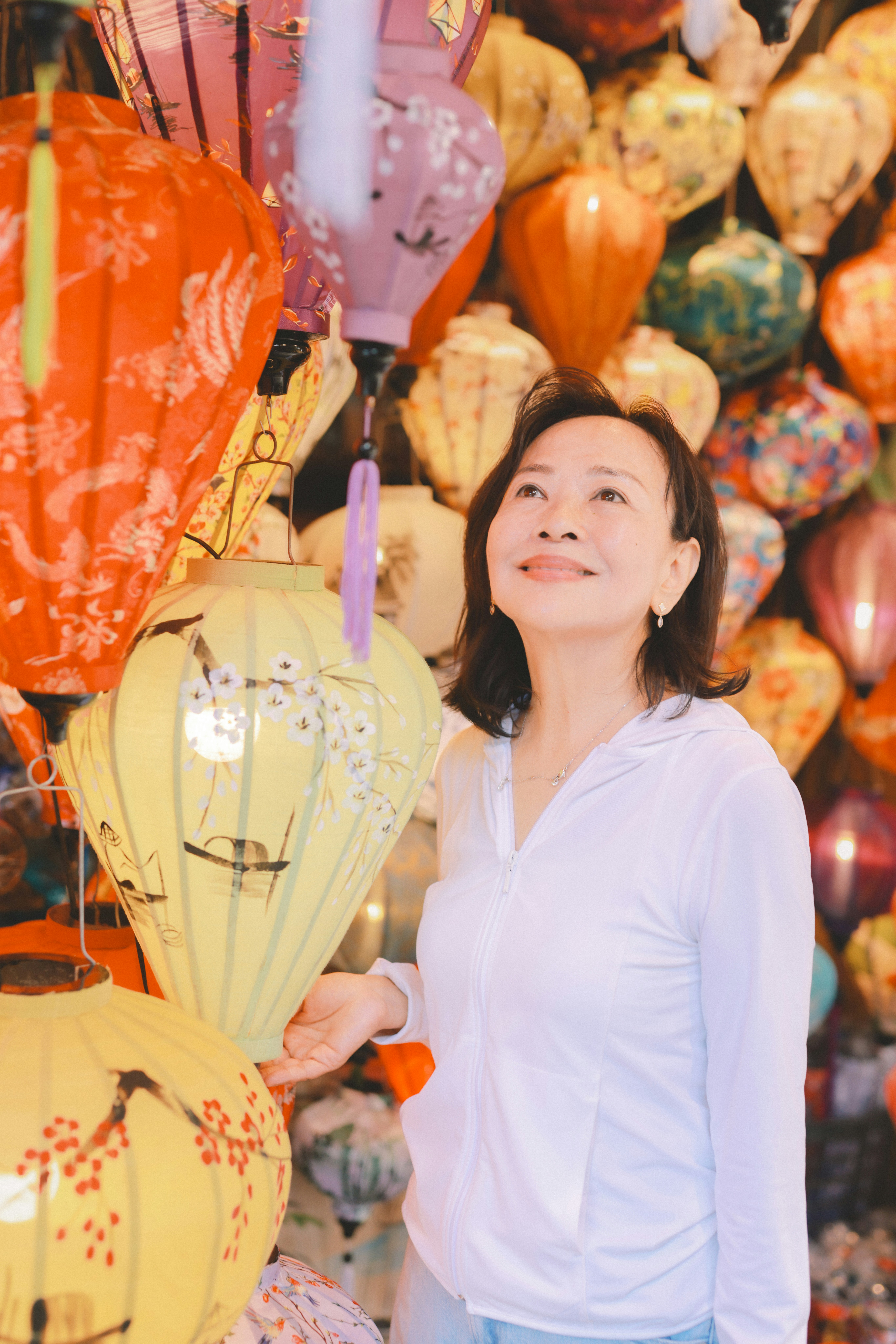 Lantern-lit Portrait: A Joyful Moment Among Floating Orbs