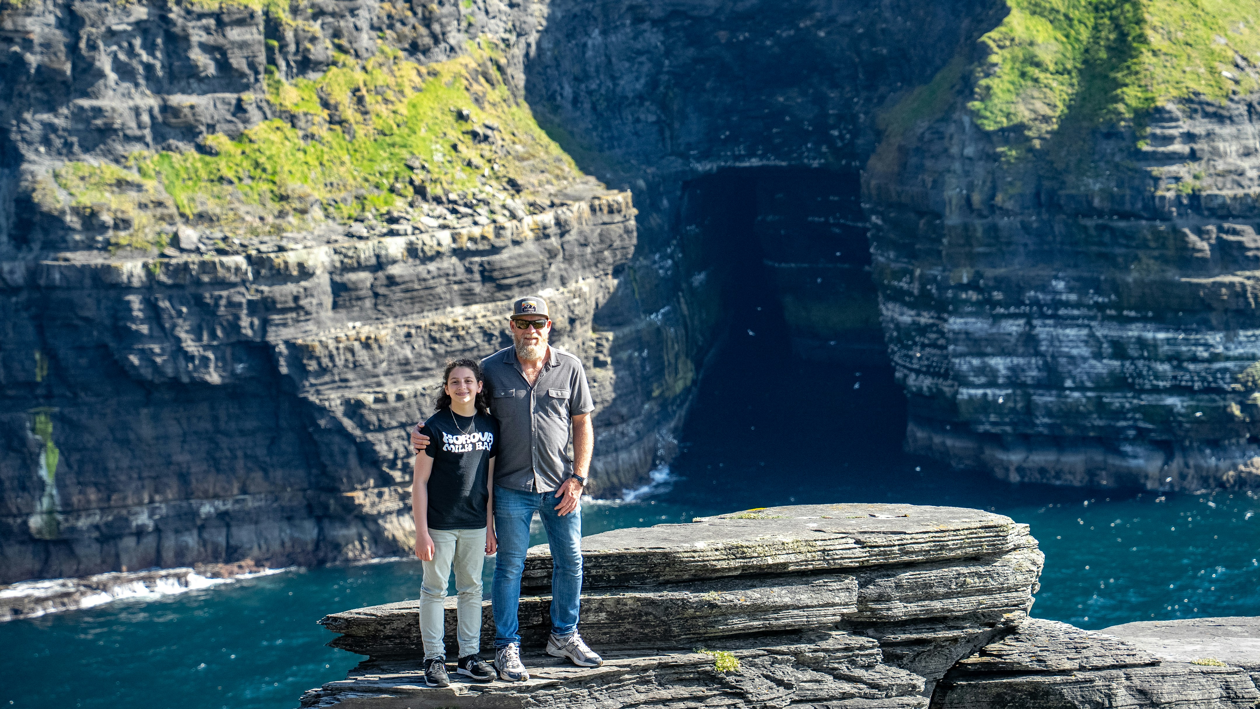 Two Explorers at a Seaside Cliff