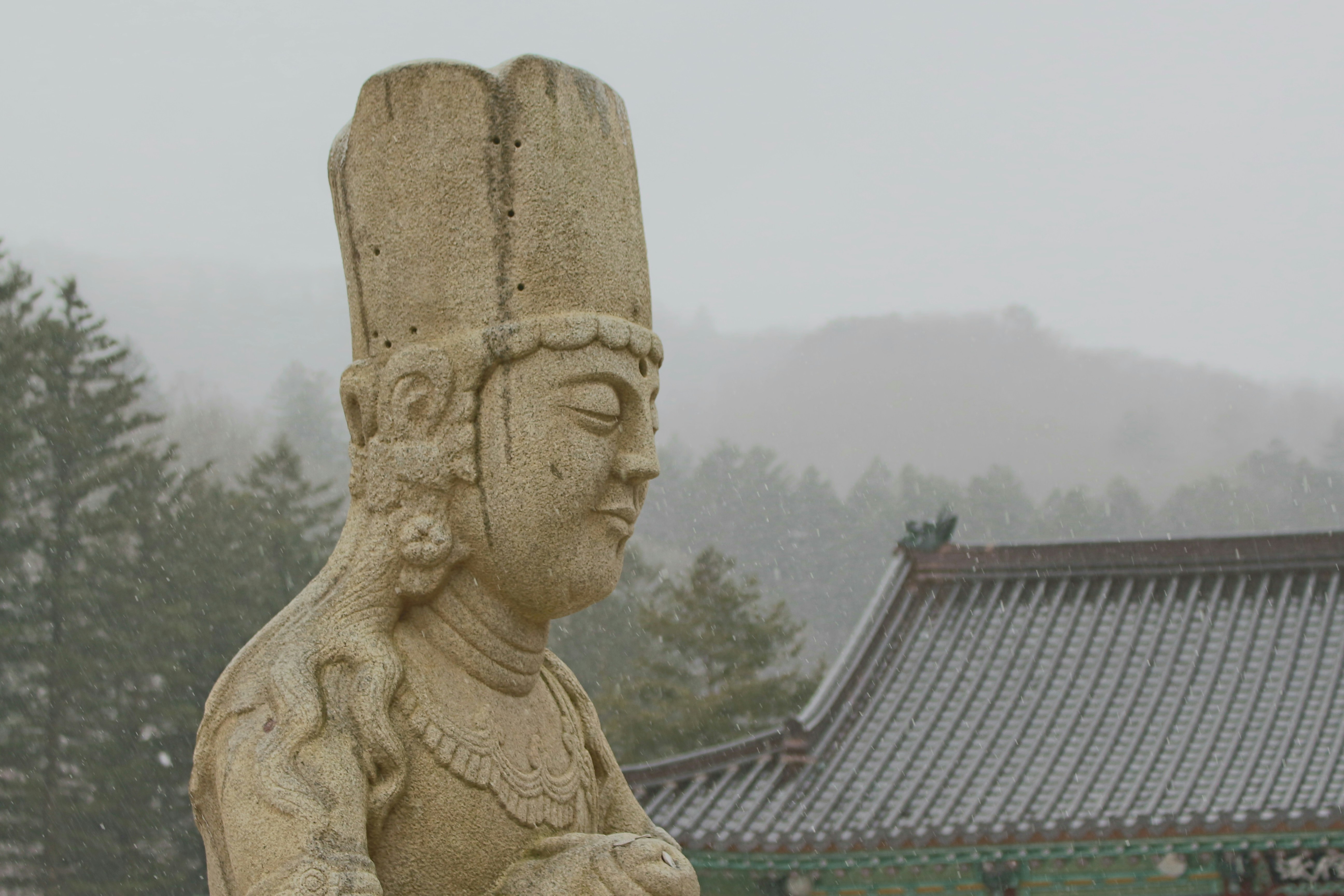 Stone Guardian Amid Quiet Mist at the Temple Courtyard