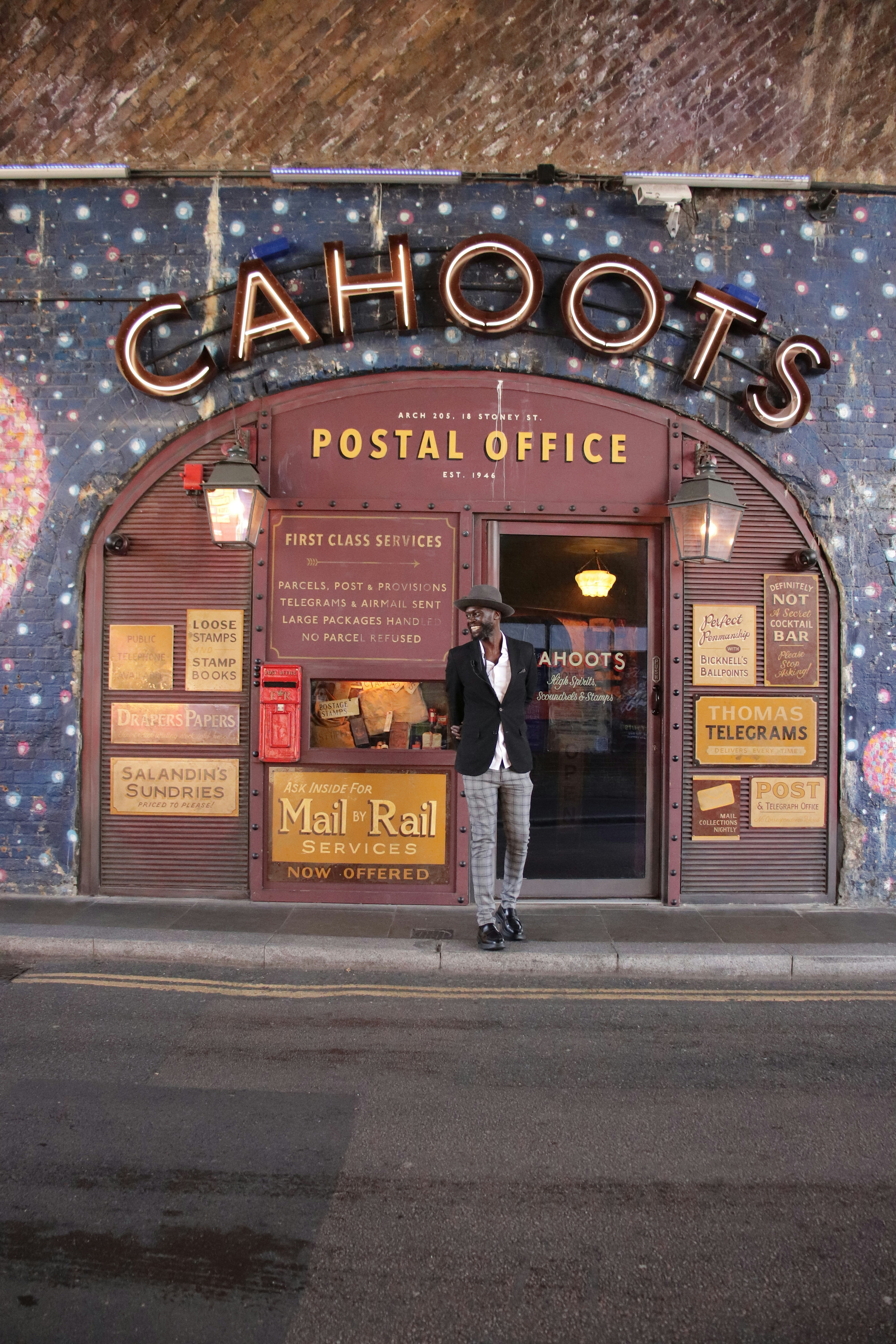 Man stands outside a vintage postal office building. photo – Free Brick ...