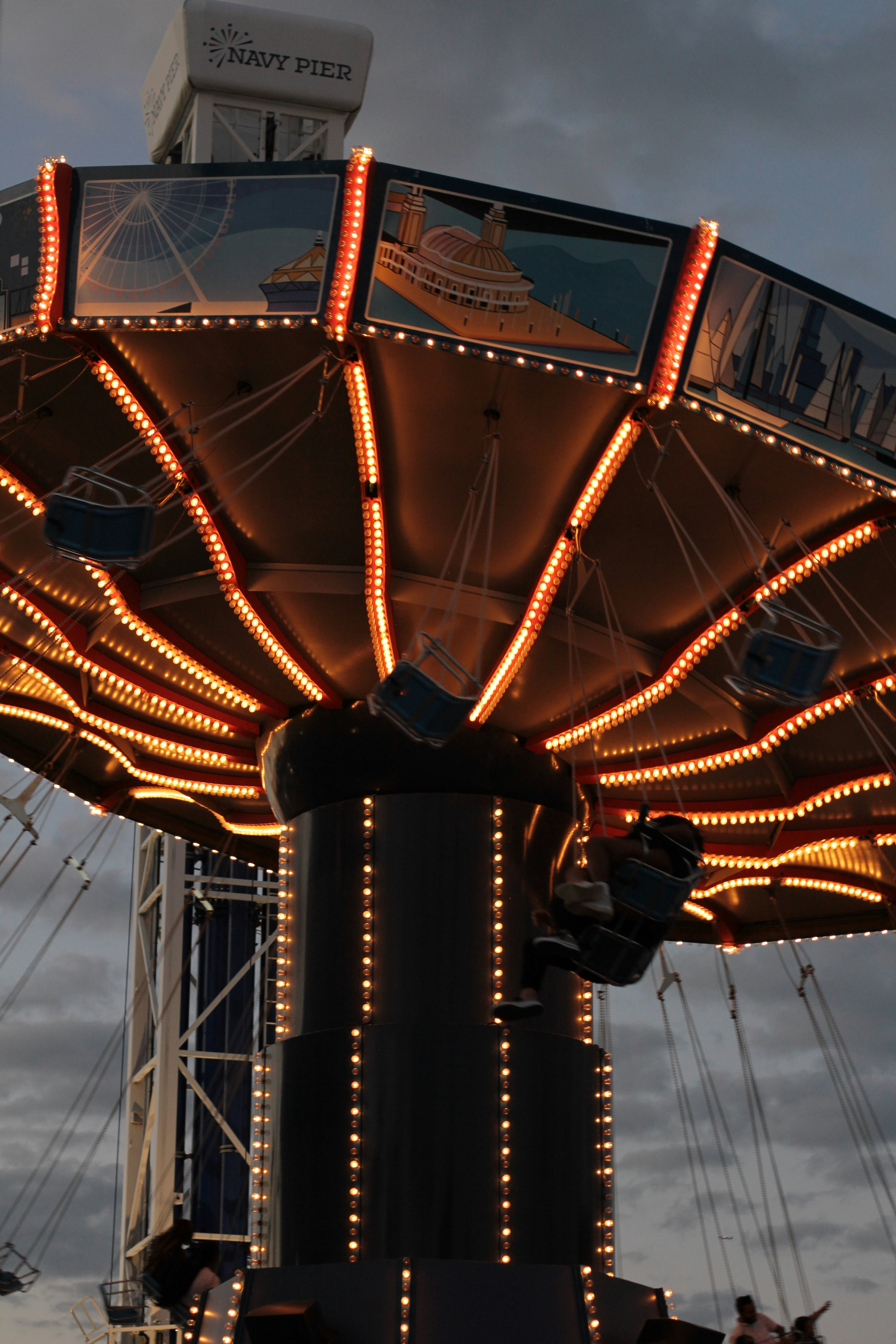 Glow-Studded Carousel Spindle Under Dusky Sky