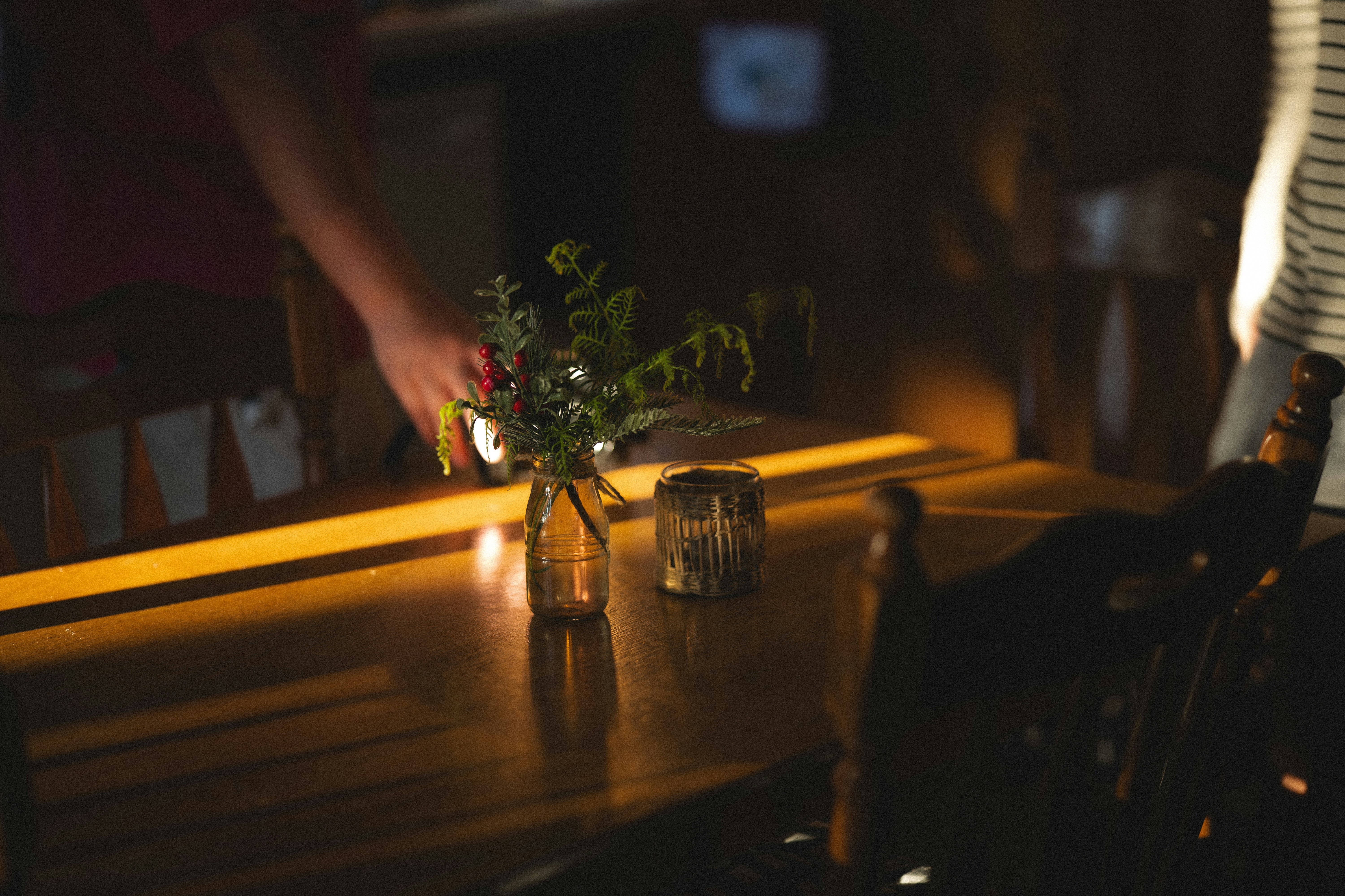 Backlit Bar Counter with Floral Arrangement and Busy Silhouettes