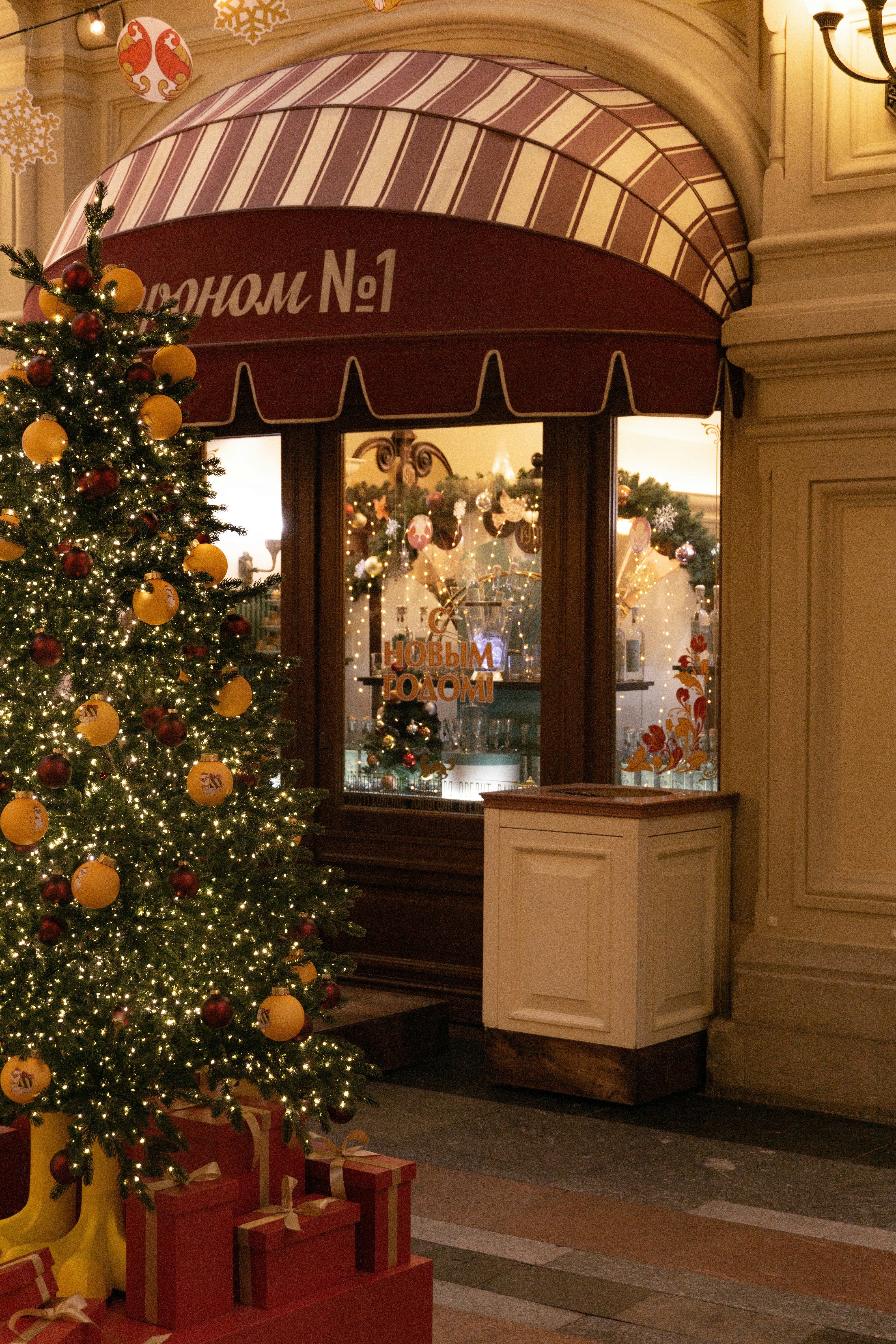 Holiday Corner: A Christmas Shopfront Framed by a Lush Tree
