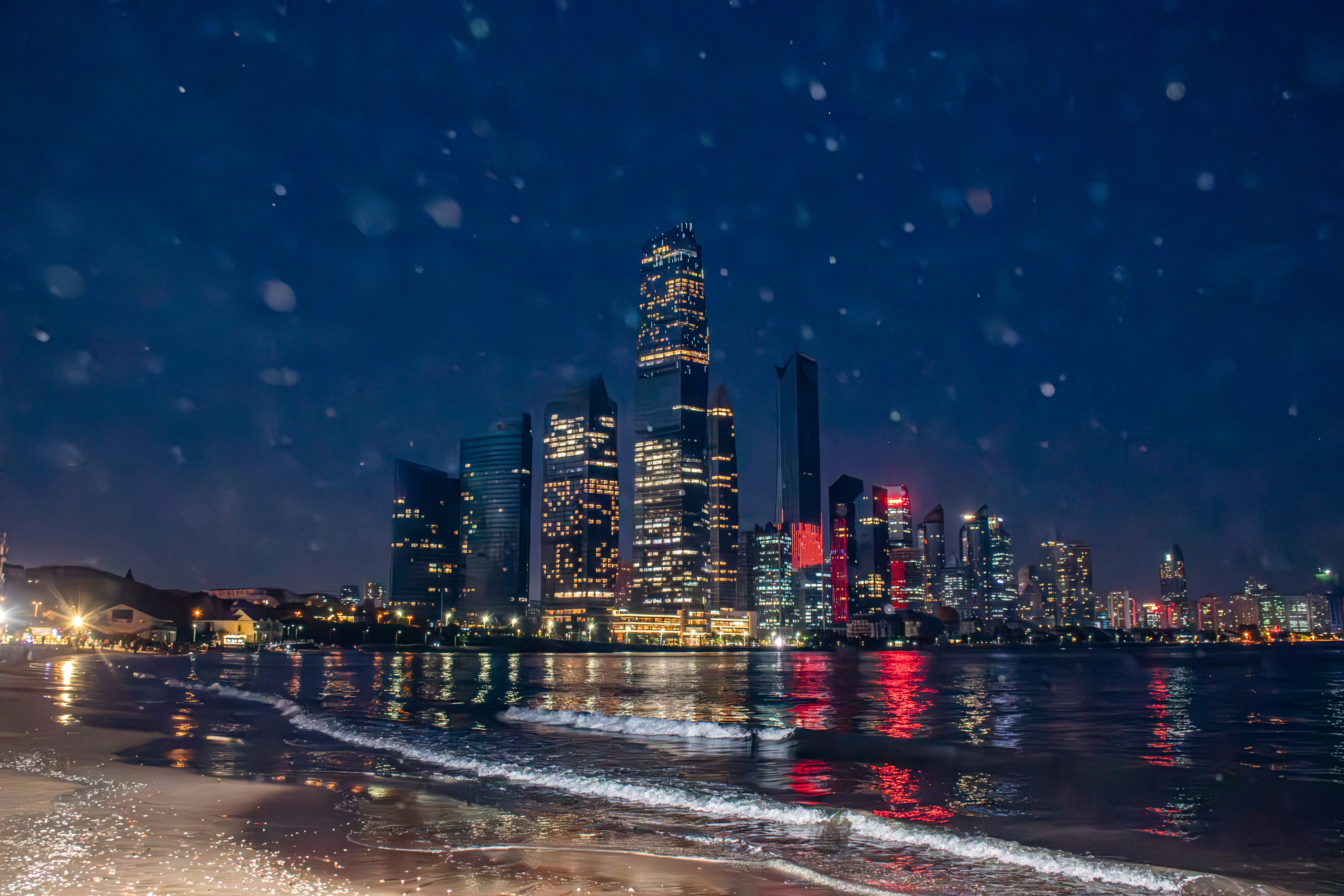 Rainy Night Skyline: City Lights Reflect on A Quiet Bay
