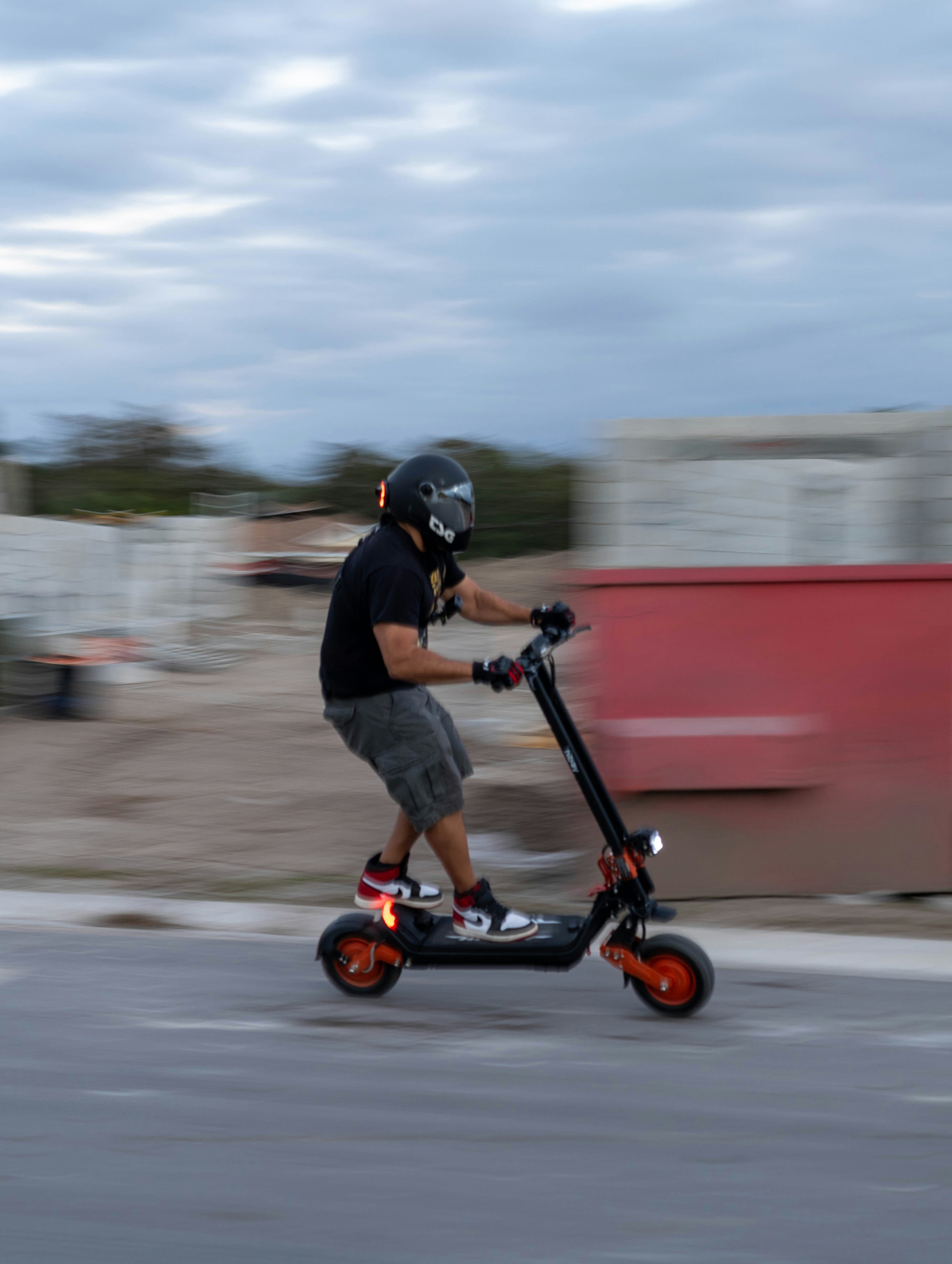 Urban Thrill: Riding a Neon-Tired Scooter Through a Blurred City Moment
