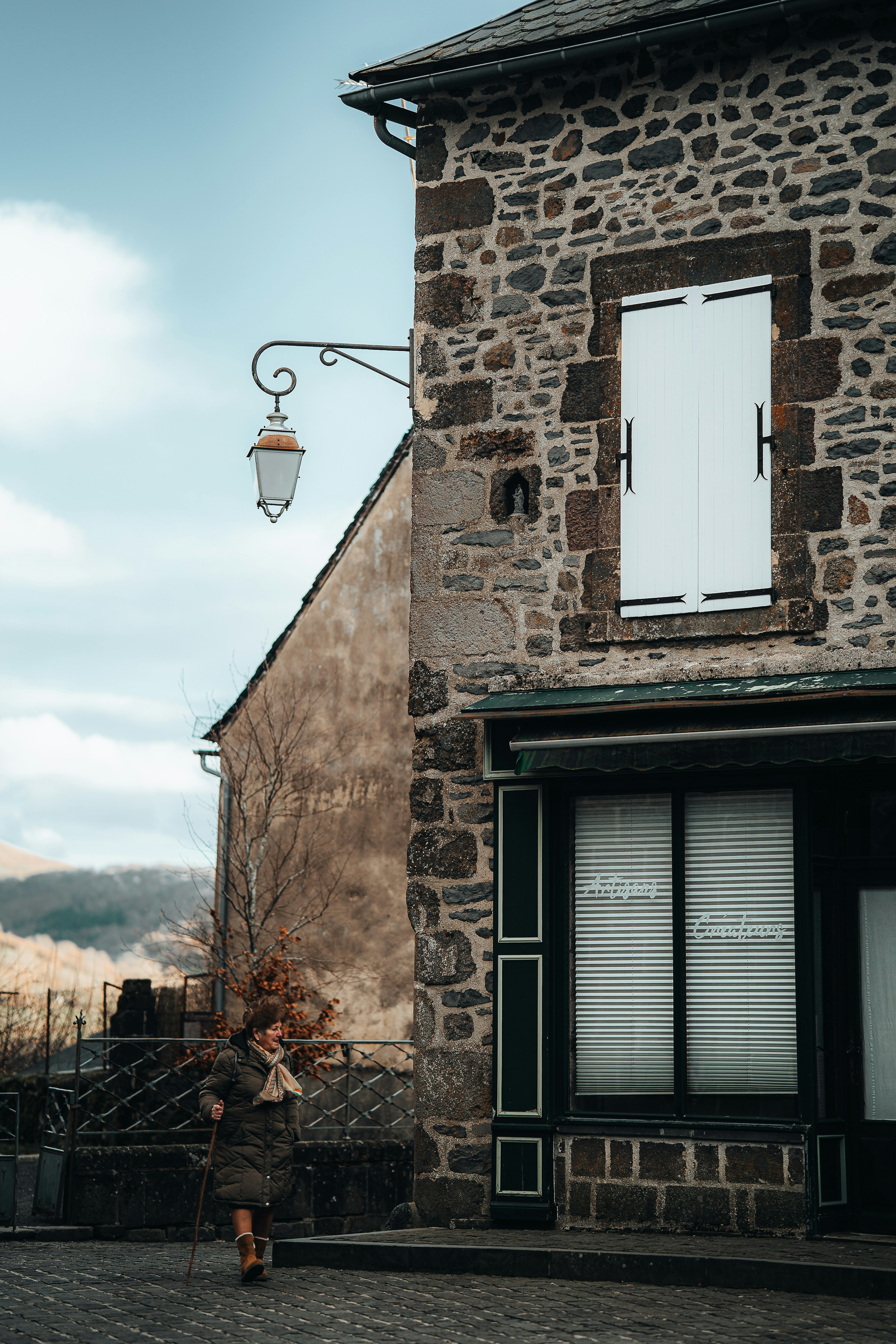 Cobblestone Facade and Dweller in the Quiet Corner