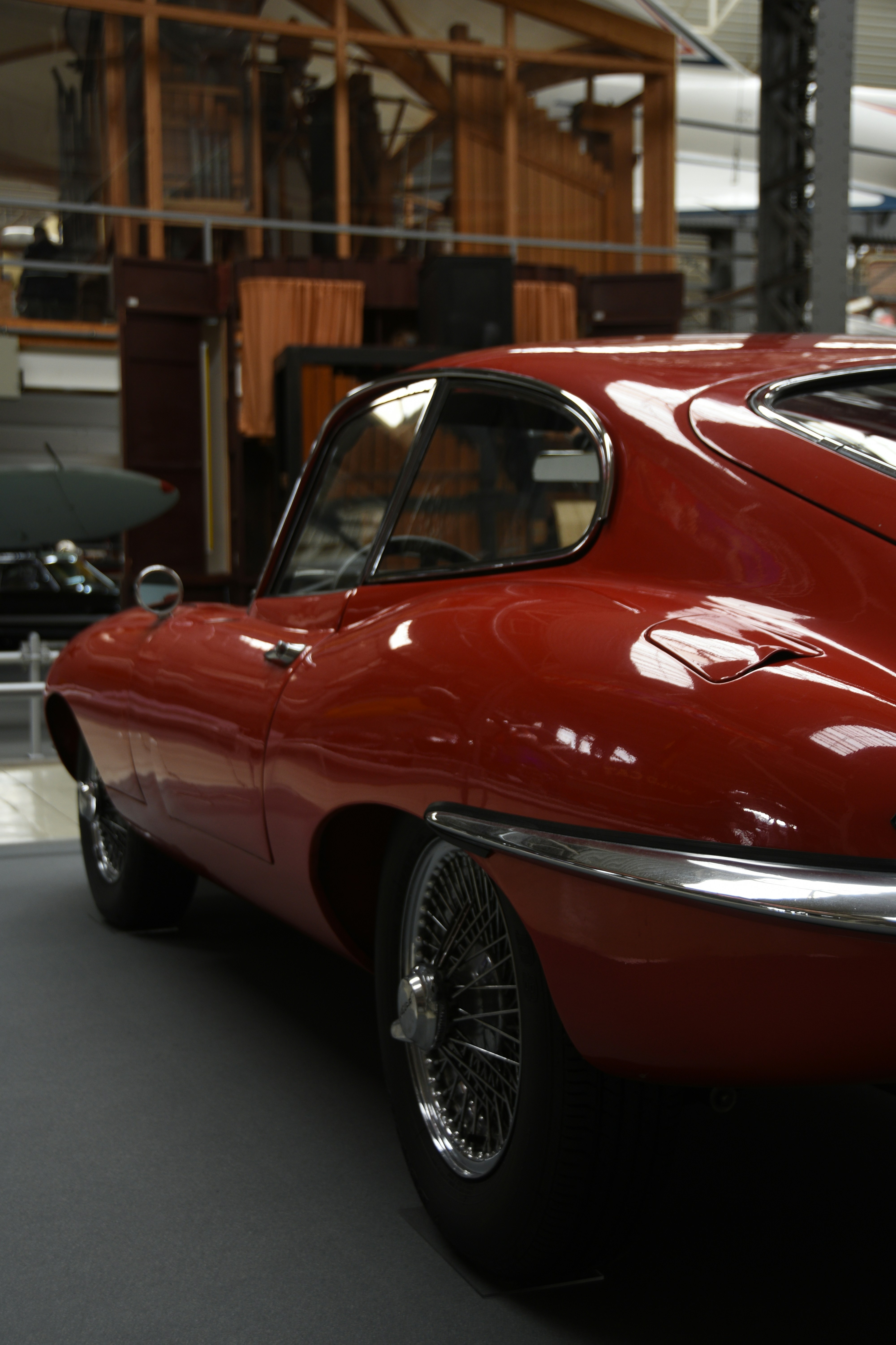 Classic Red Curves: A Vintage Car at Rest in an Interior Display