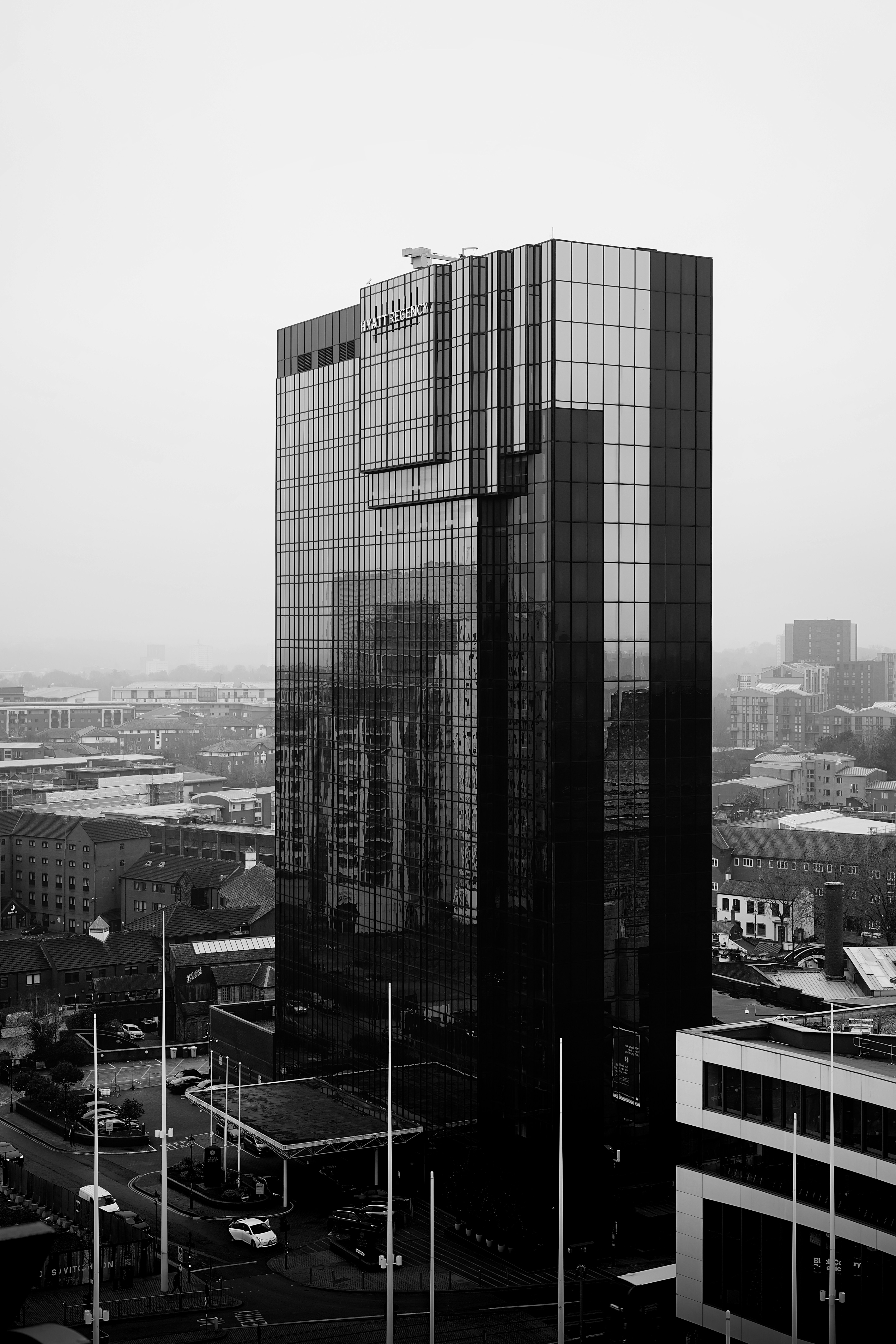 Glass Tower Reigns Over a Quiet Urban Fold