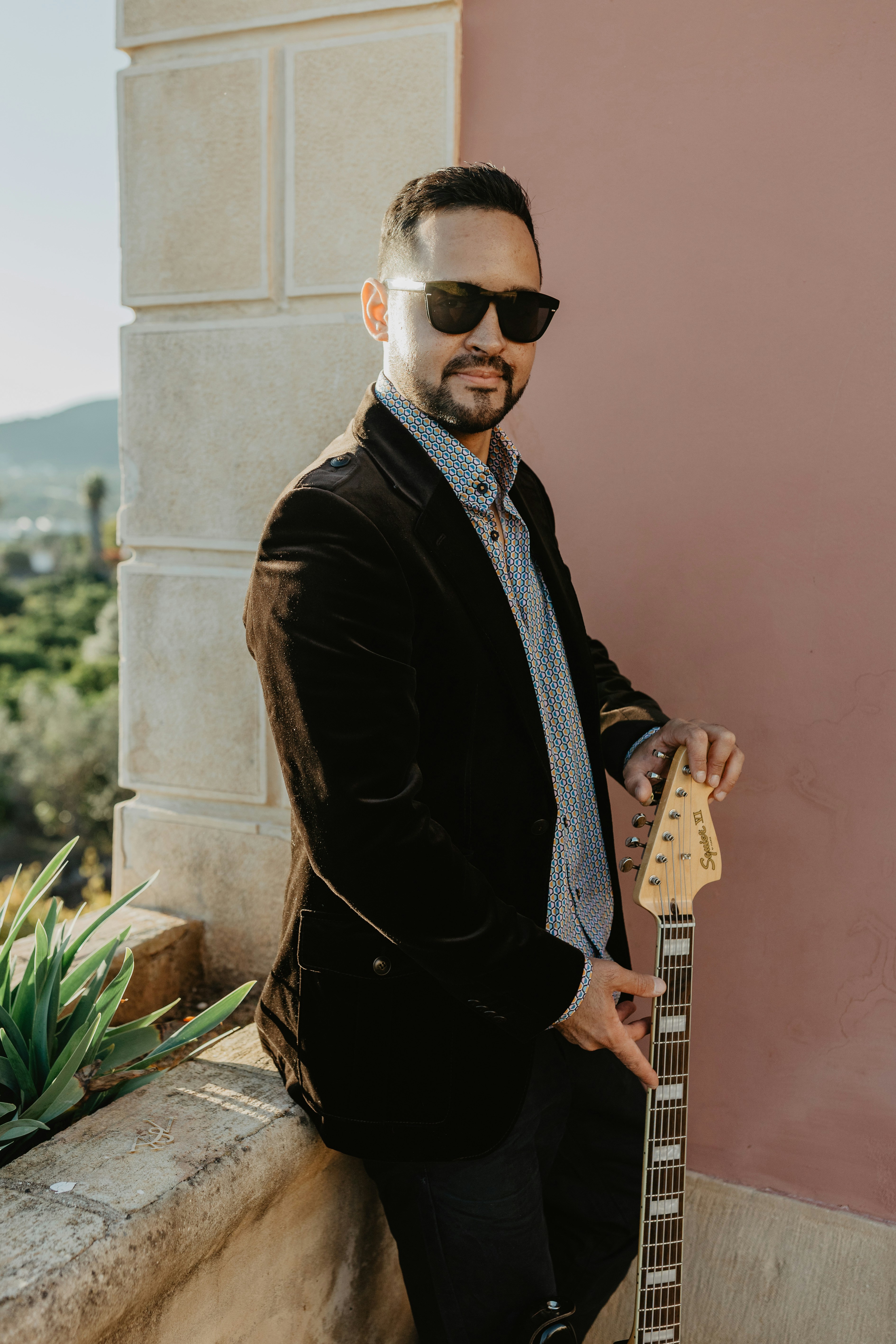 Guitarist at the Terrace: Shadowed Confidence in a Sunset Tone