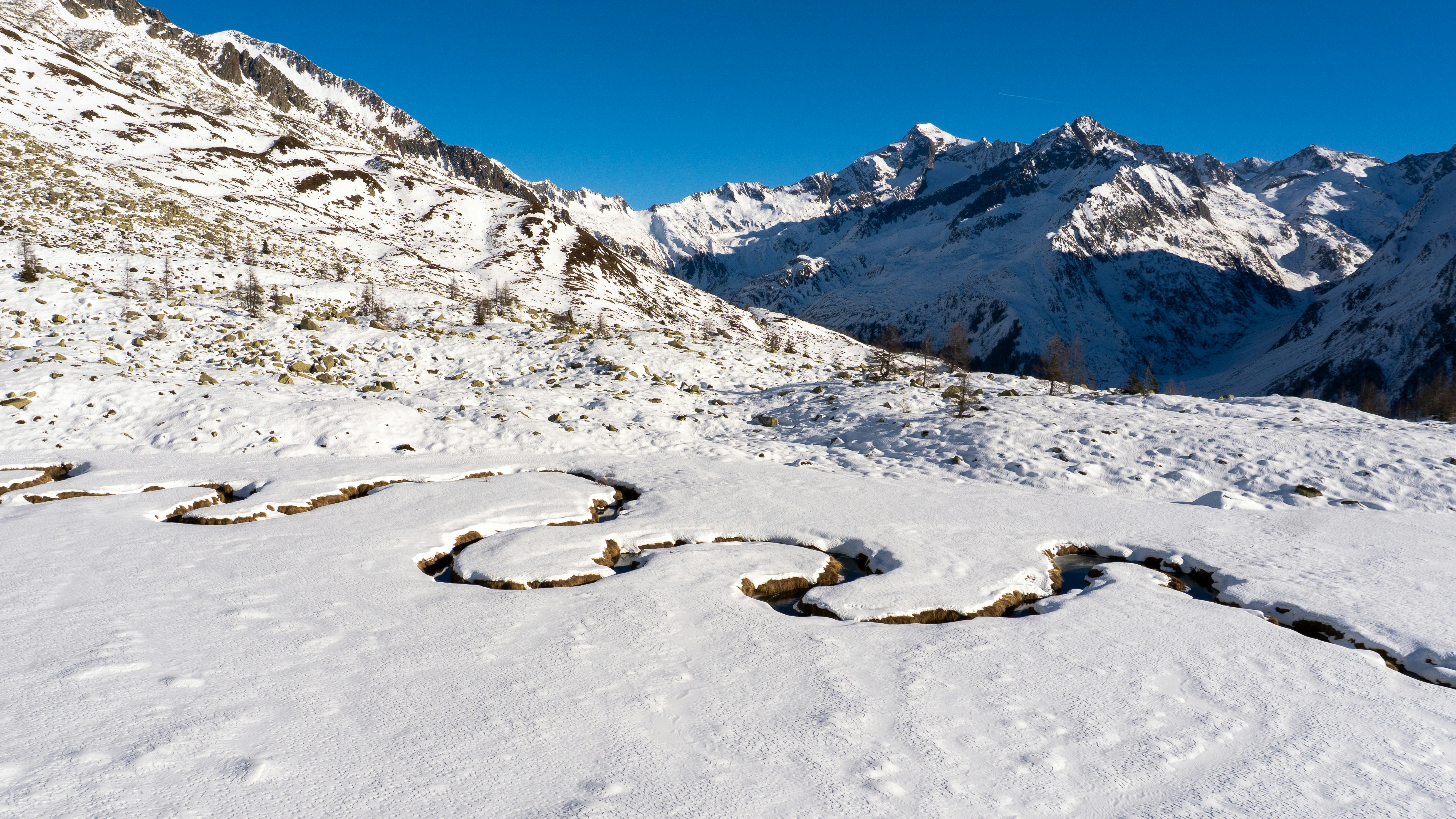 Snow-kissed terrace of stone steps under cobalt sky