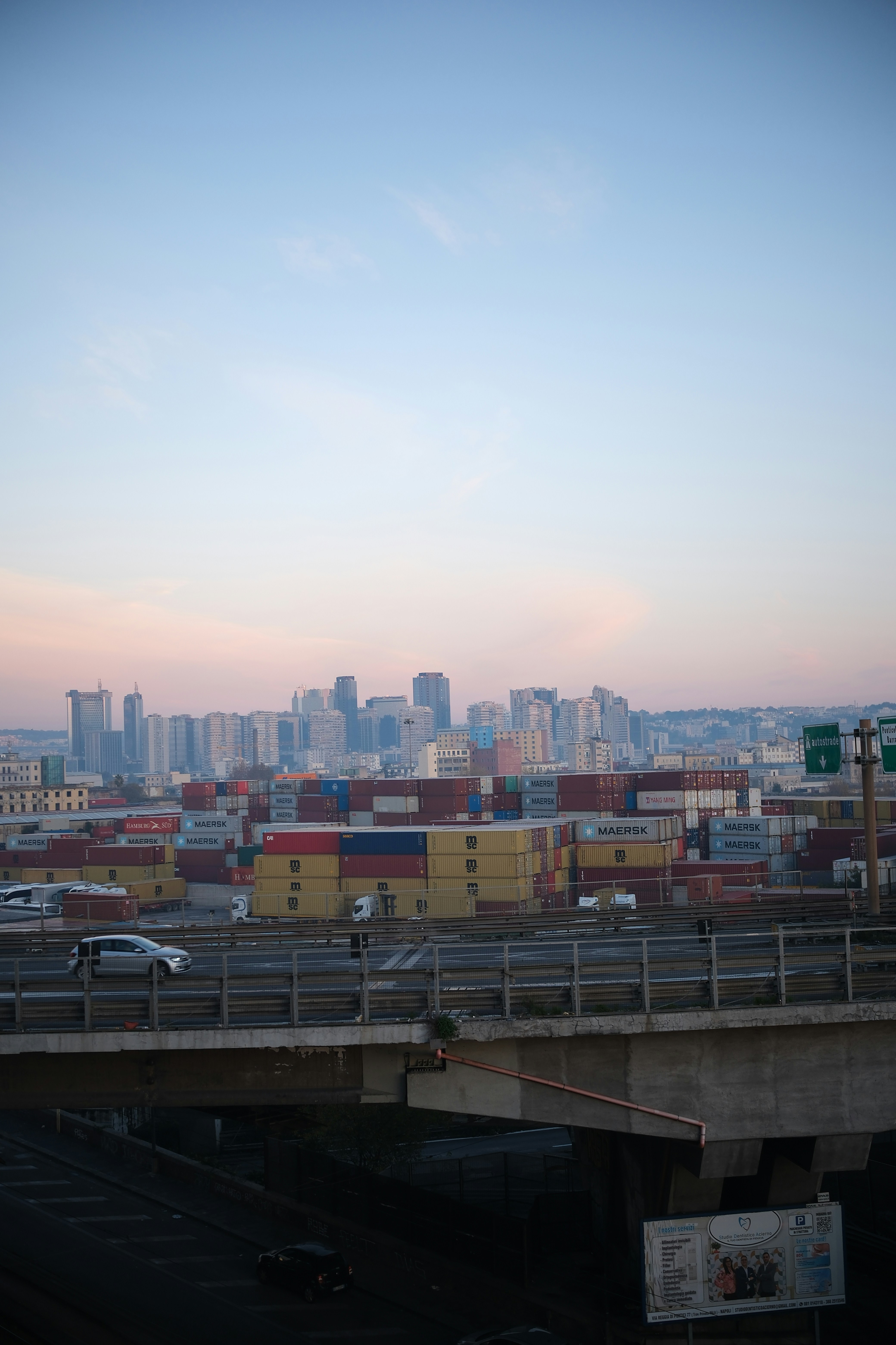 Container cityscape at dusk from an overpass