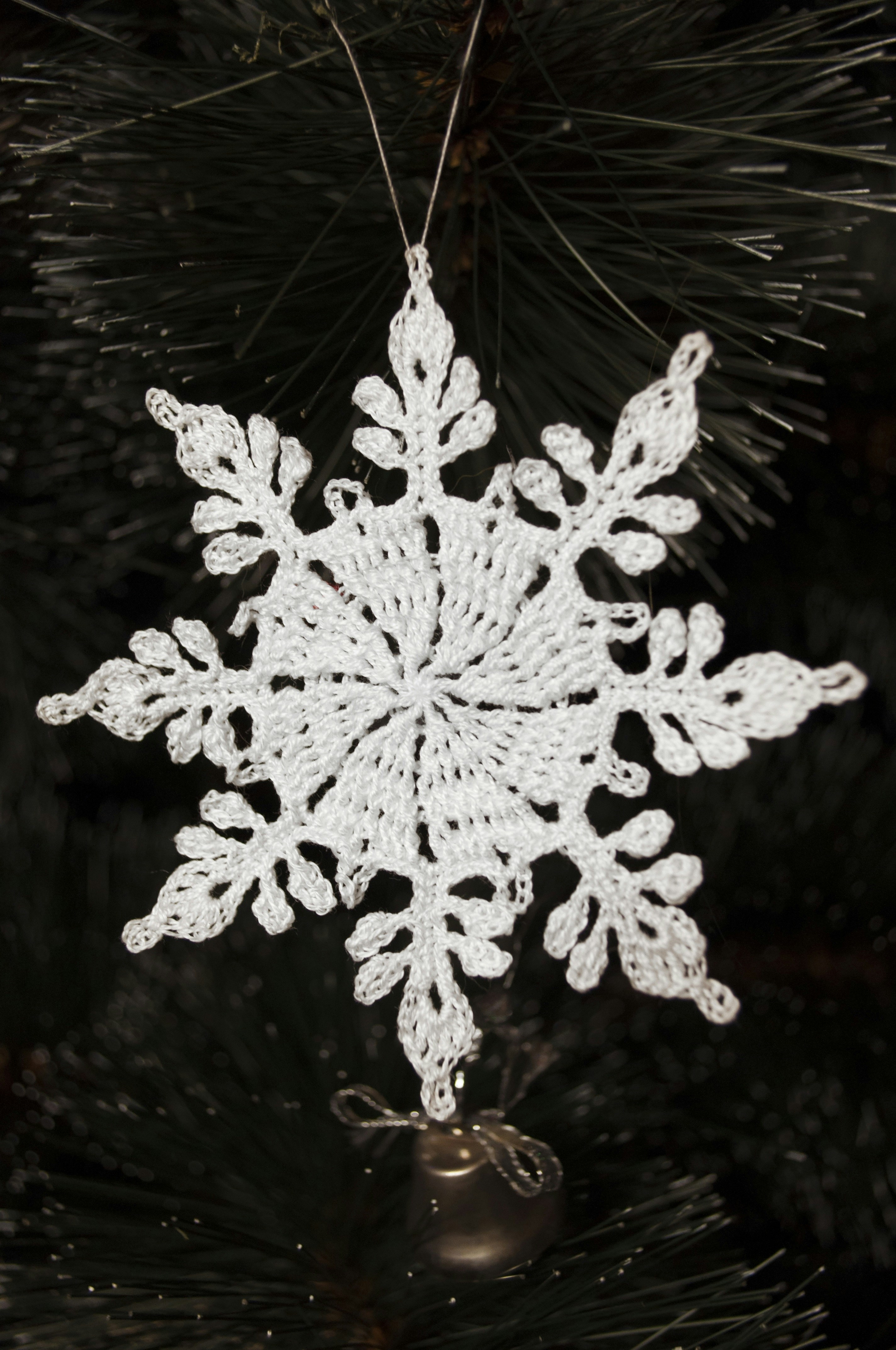 Snowflake Ornament: a delicate centerpiece in a dark pine Christmas scene