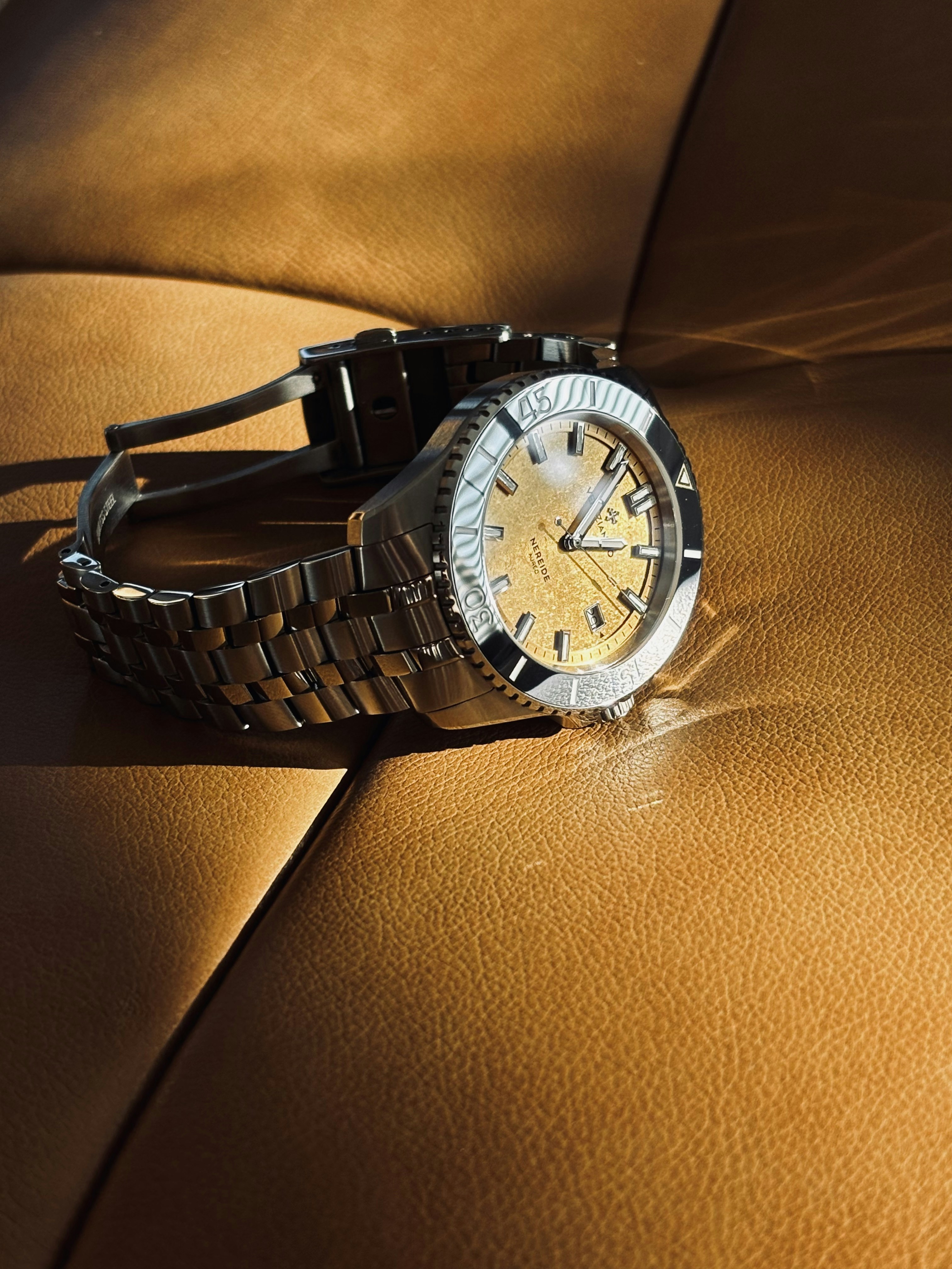 A stainless steel watch with a gold dial. photo – Free Fashion Image on ...