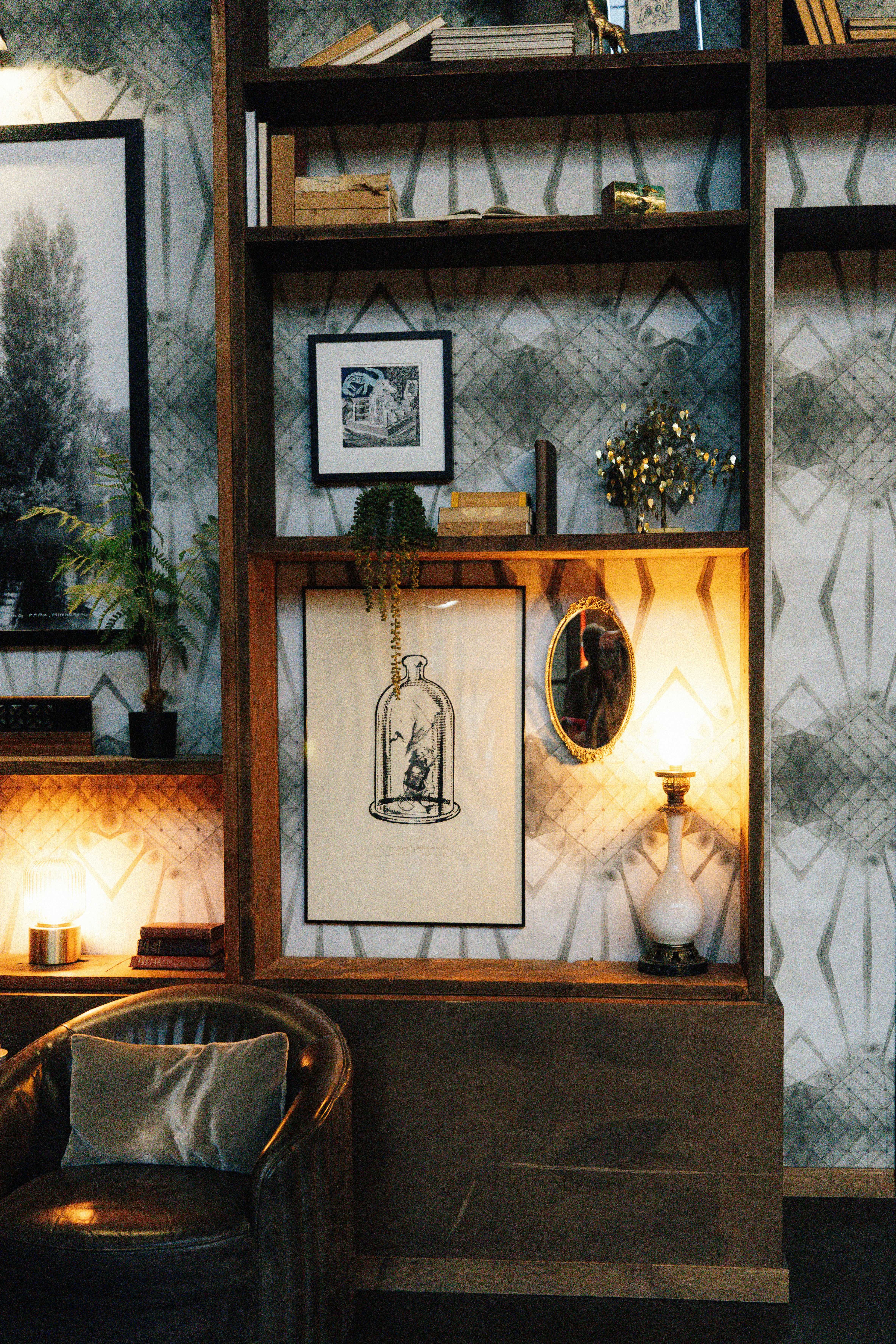 Warm Library Nook: A Corner of Lighted Shelves and Framed Art
