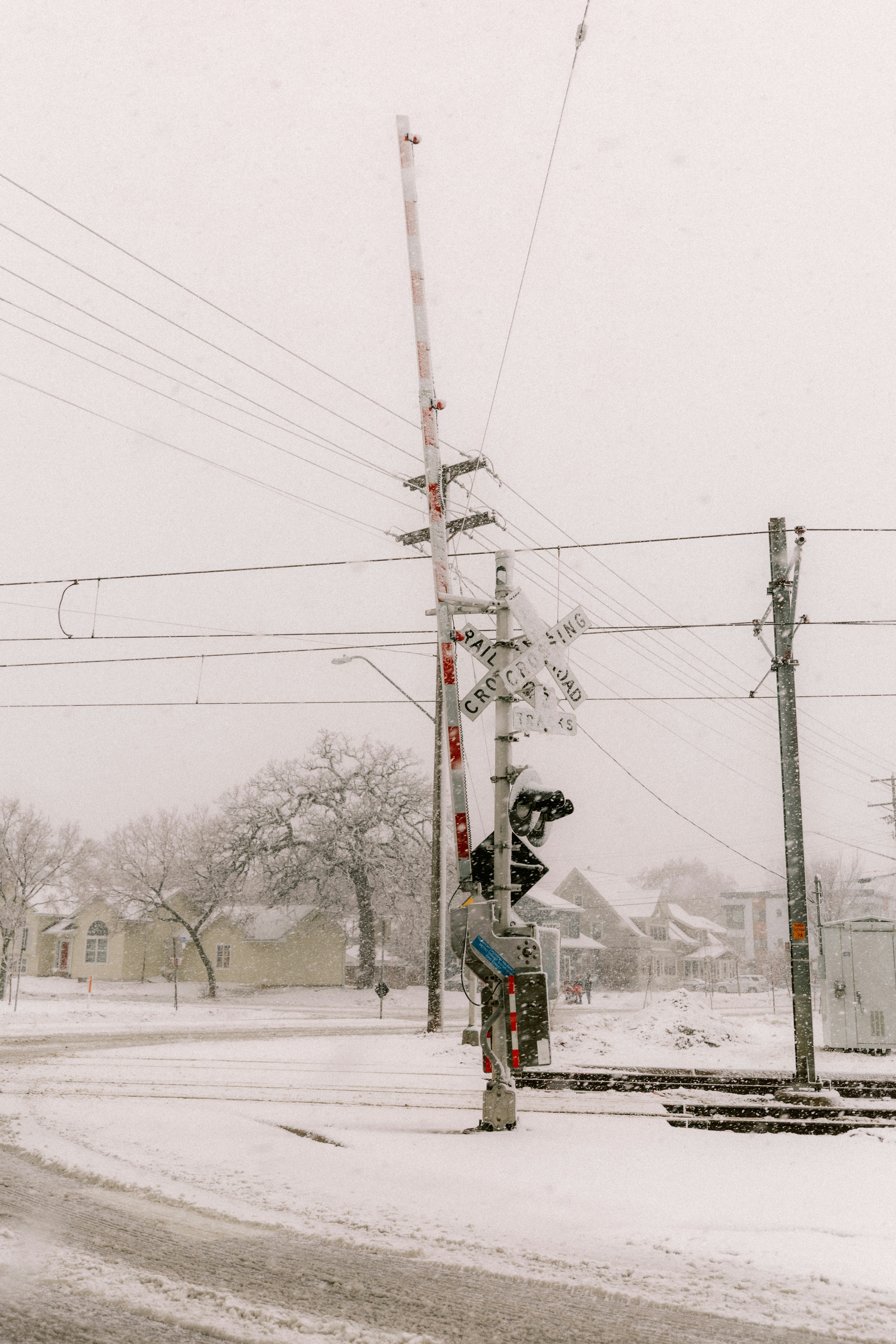 Snowbound Crossing: A Railroad Signal Stands Vigil in Quiet Blizzard