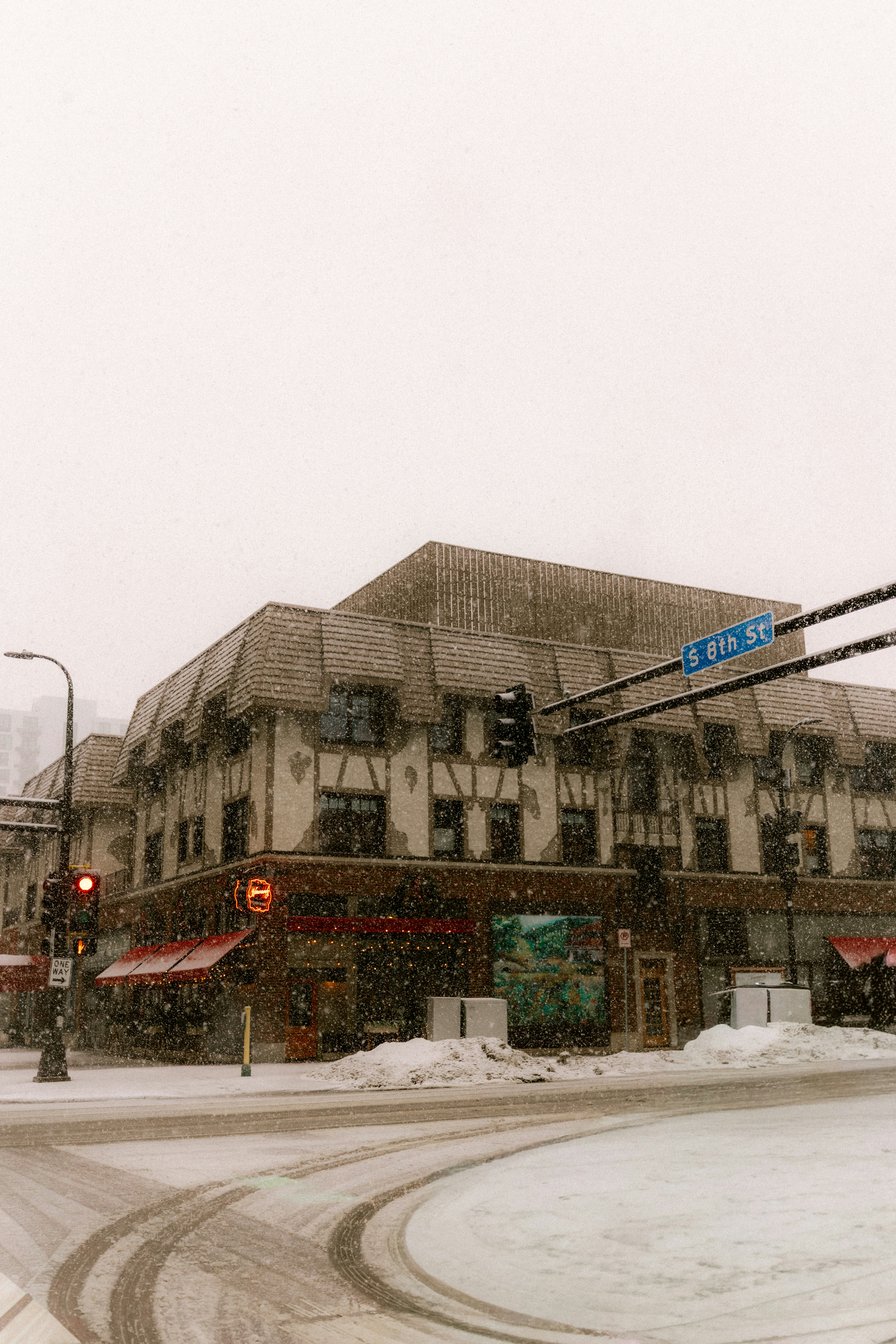 Snowy Streetfront at Dusk: Quiet Urban Pause