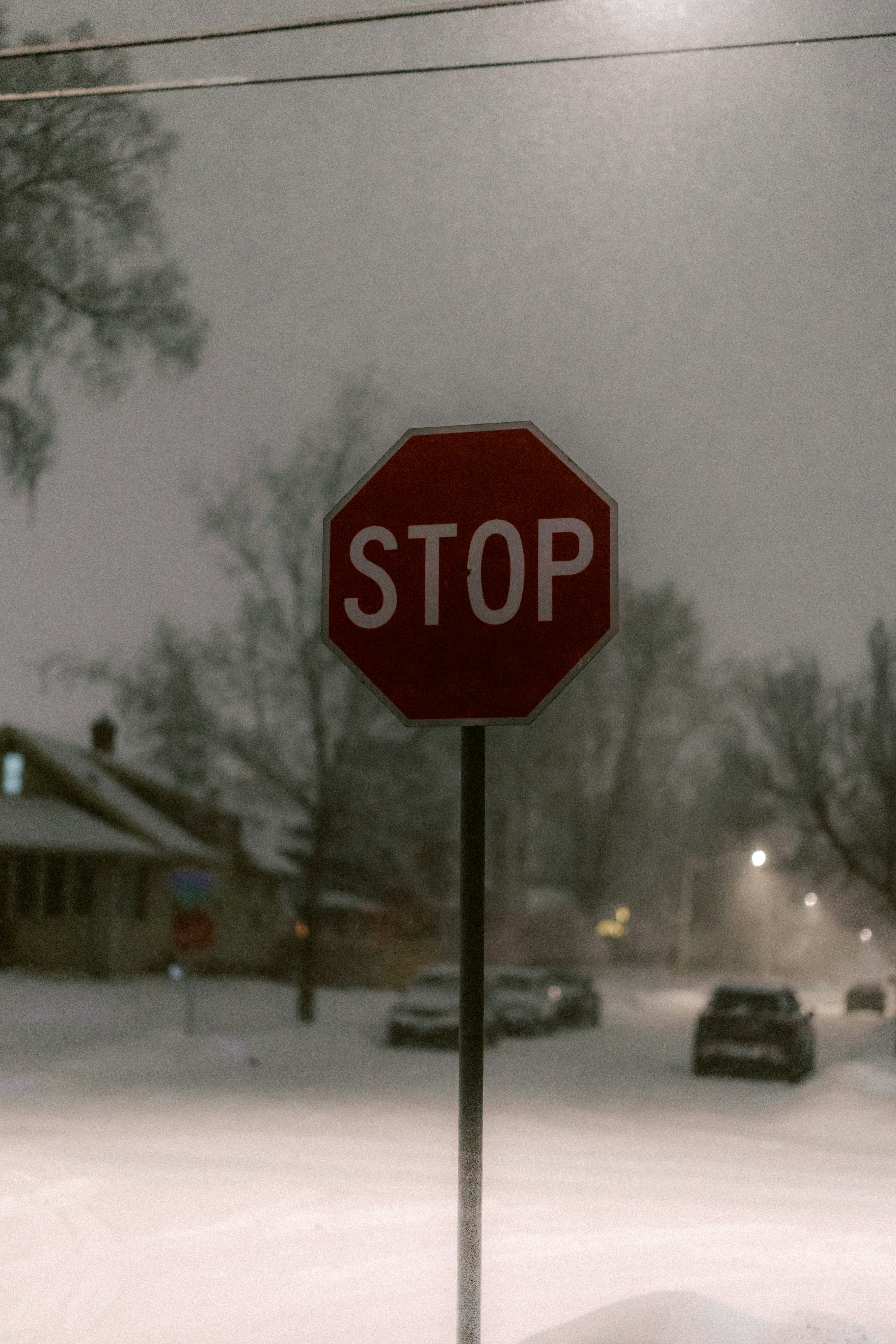 Snowy Street Stop: Red Octagonal Sign Amid Winter Quiet