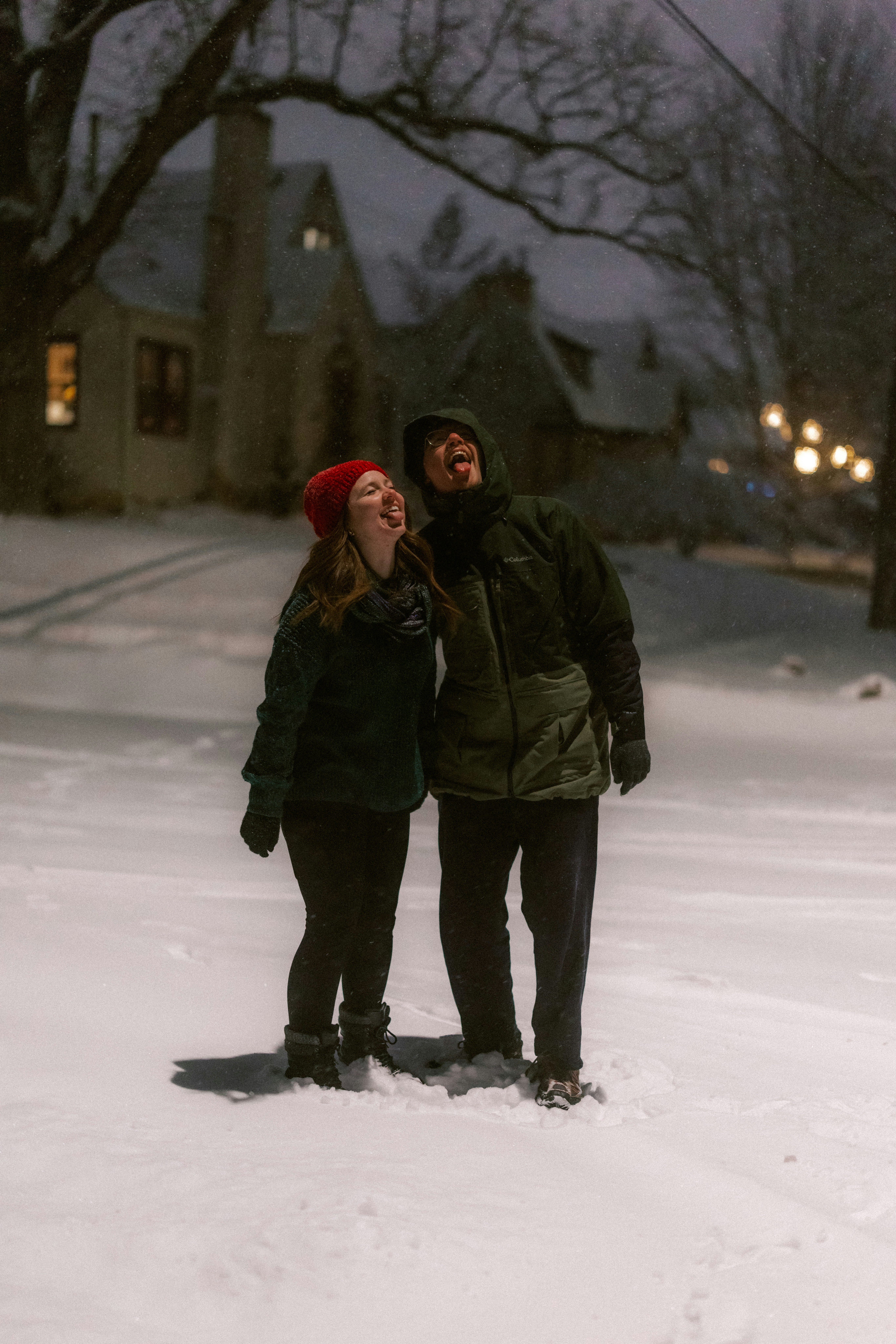 Snowy Night Laughs: A Couple Finds Joy in the Quiet Street