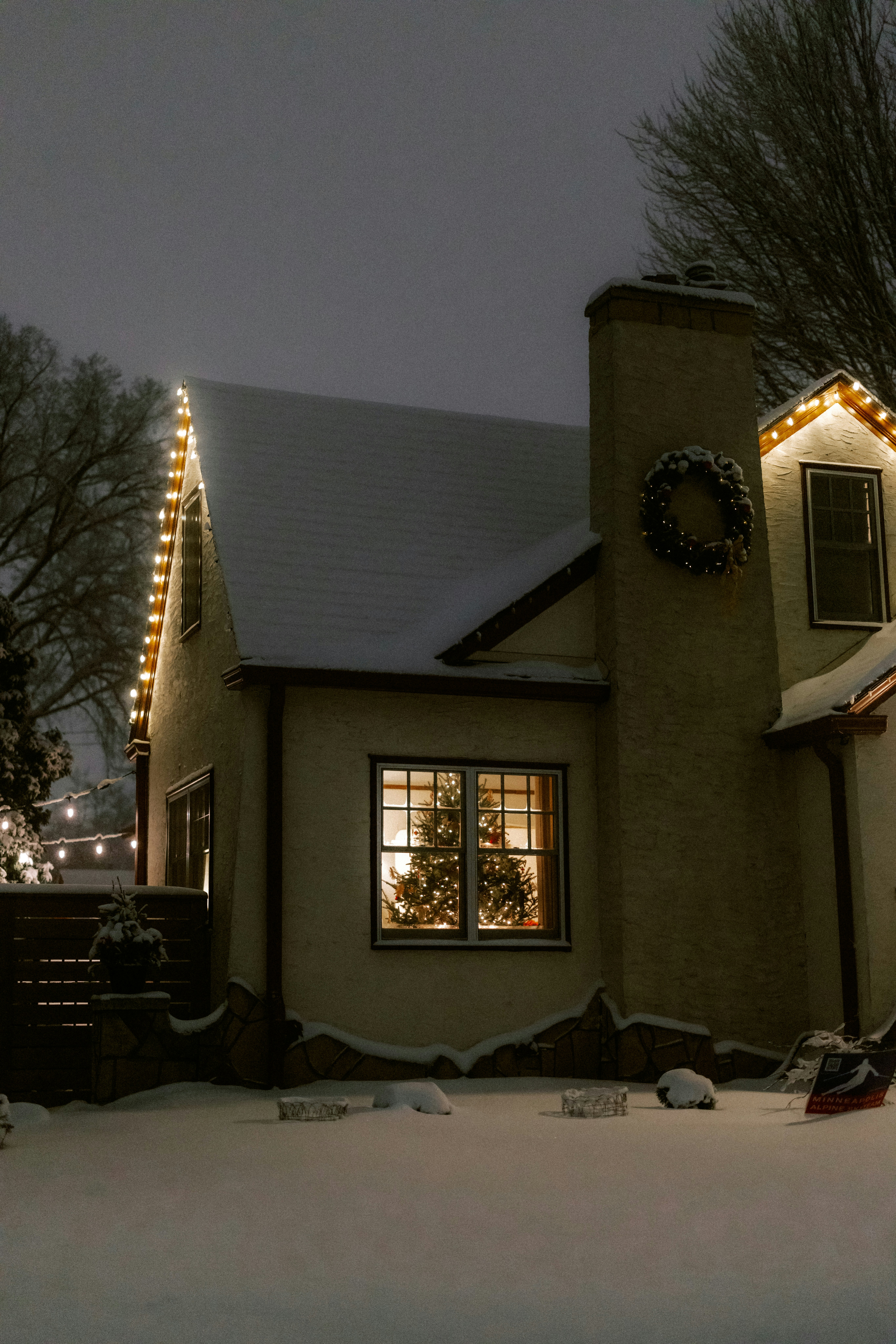 Warm Window Glow Amid Snowy Holiday House
