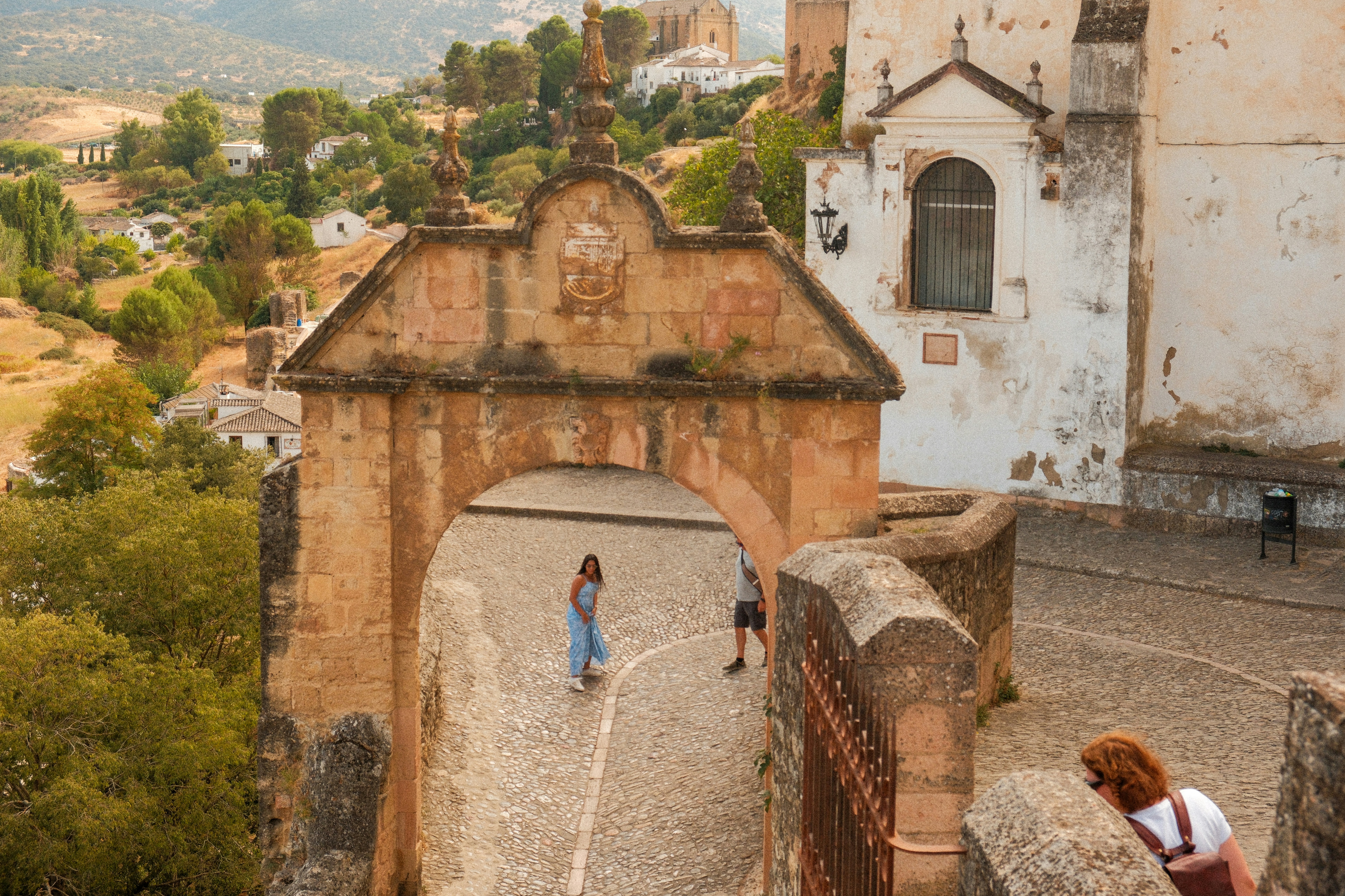 Footpath Through an Ancient Archway in a sunlit hillside town