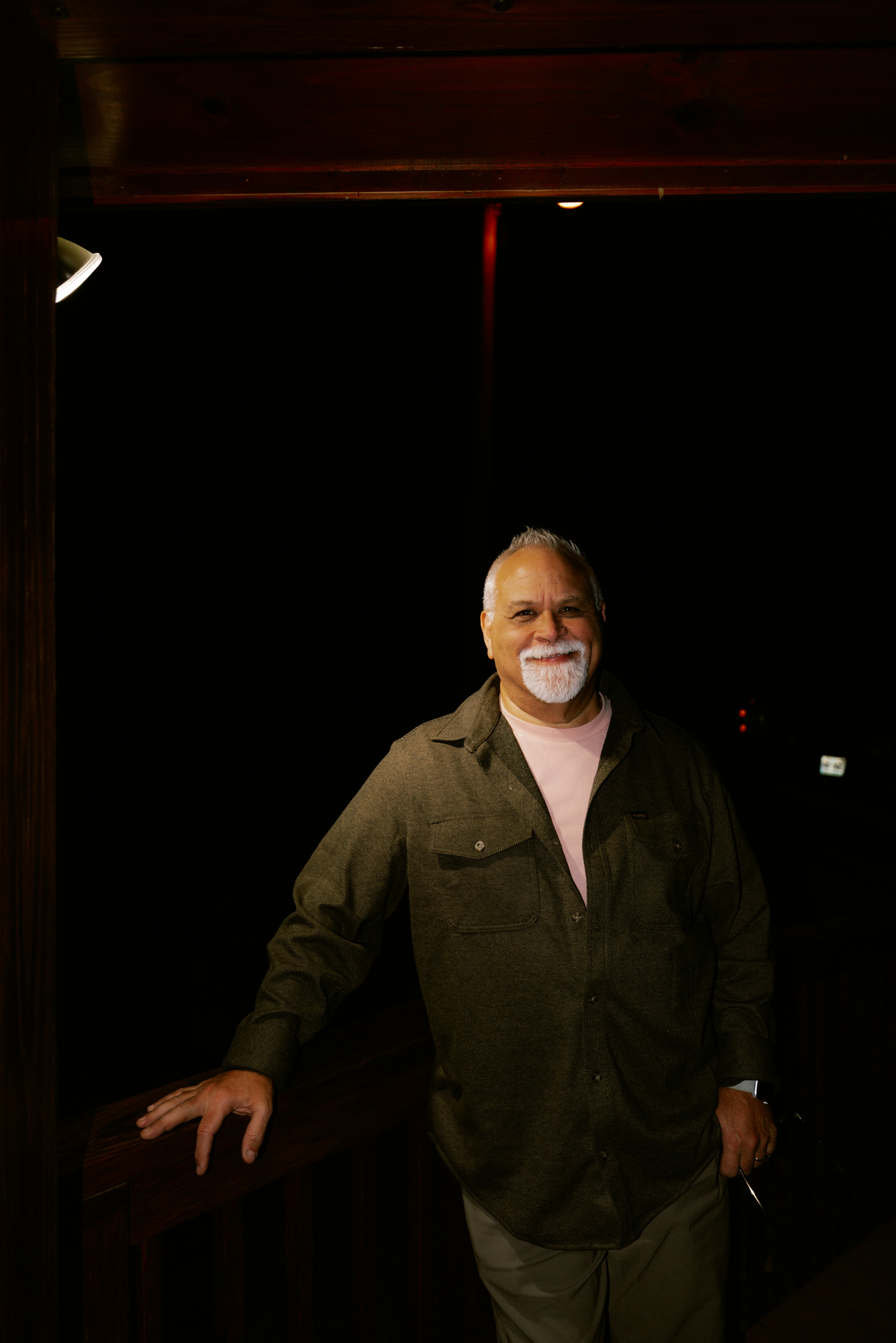 Warmth in the Dark: Portrait of a Friendly Mentor on a Quiet Balcony