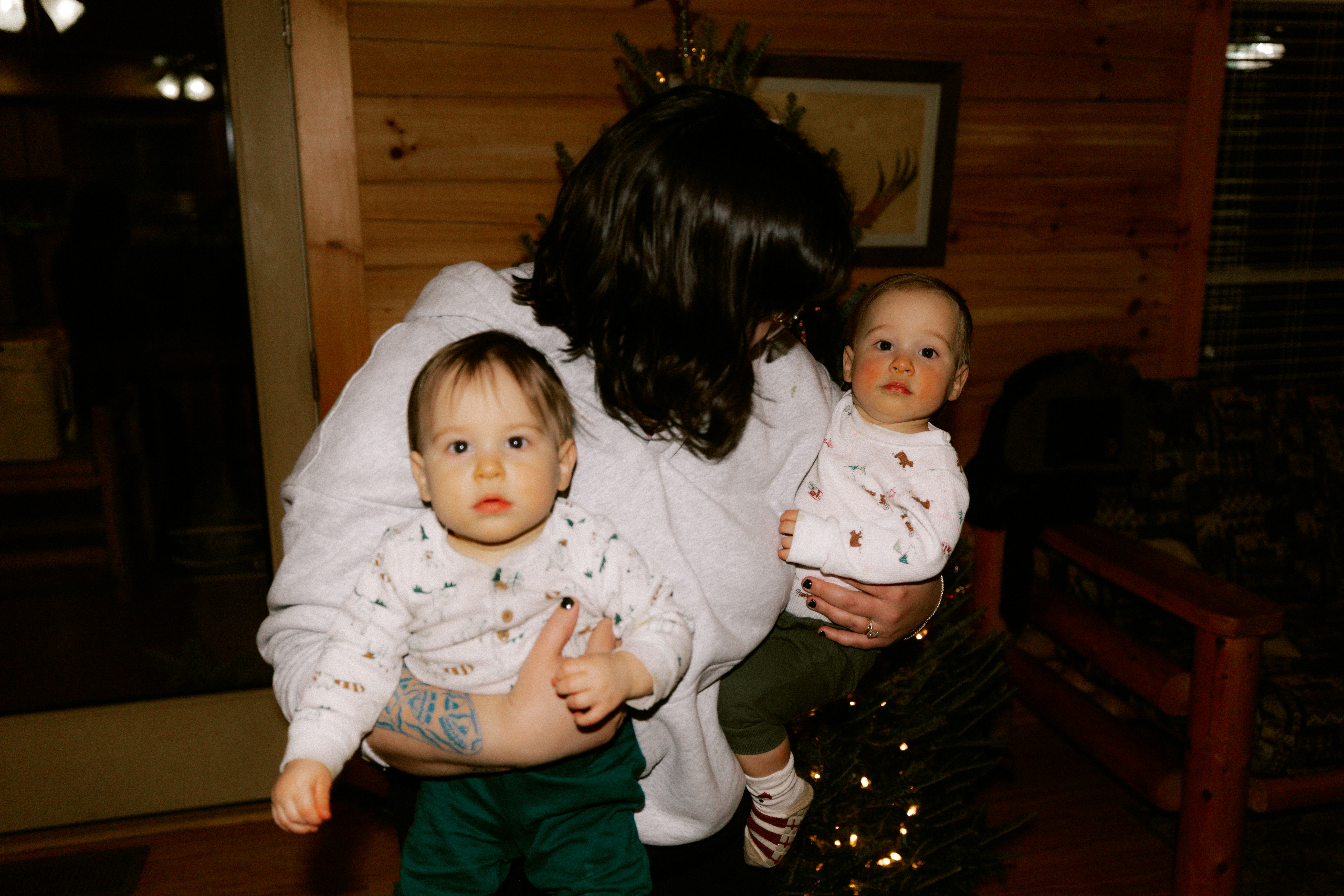 Held Hearts and Tiny Faces: A Family Moment in Warm Wood