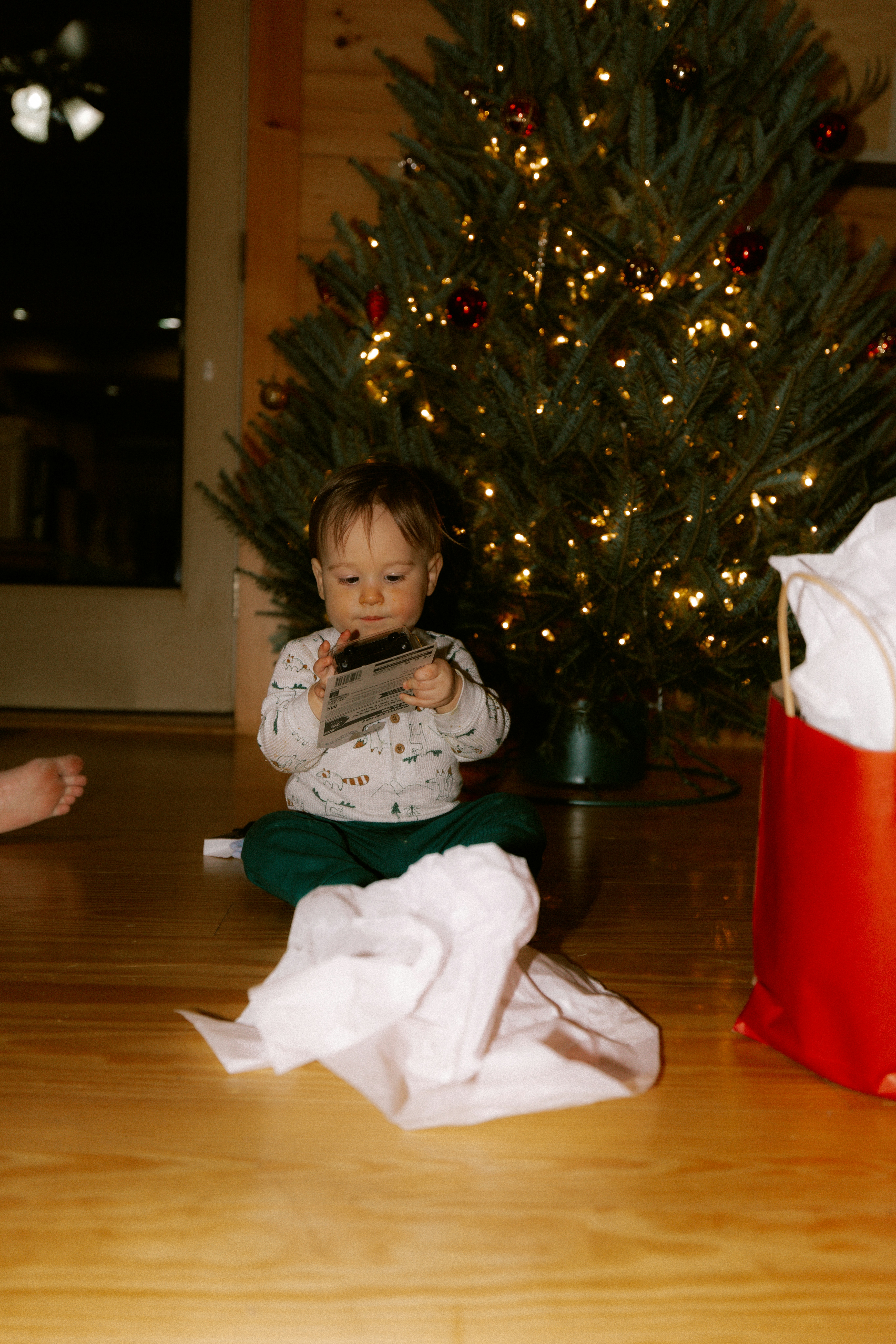 Tiny Christmas Discoveries: a child with a gift under the tree