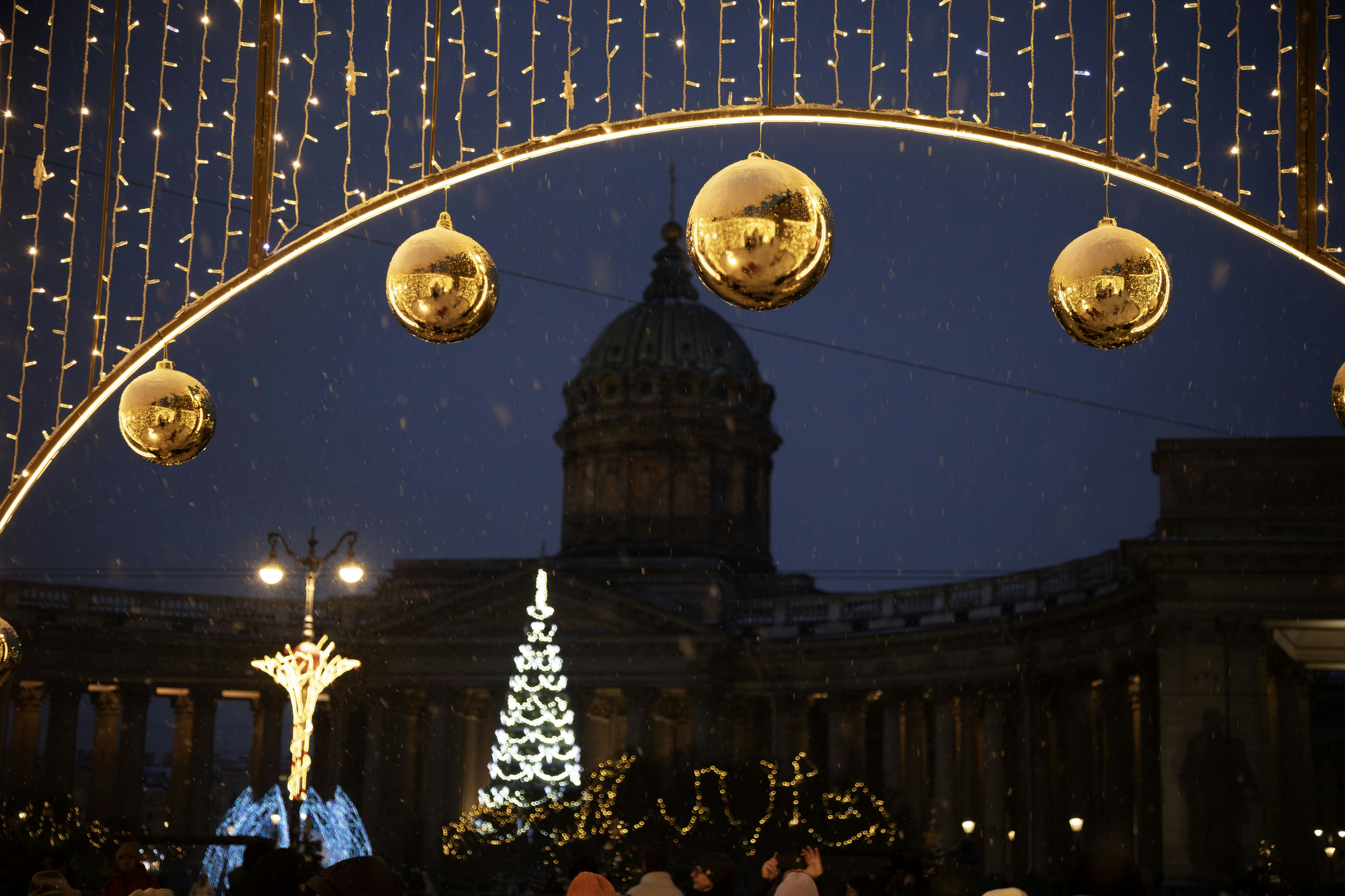  festive glow beyond the arches: a city square in twilight