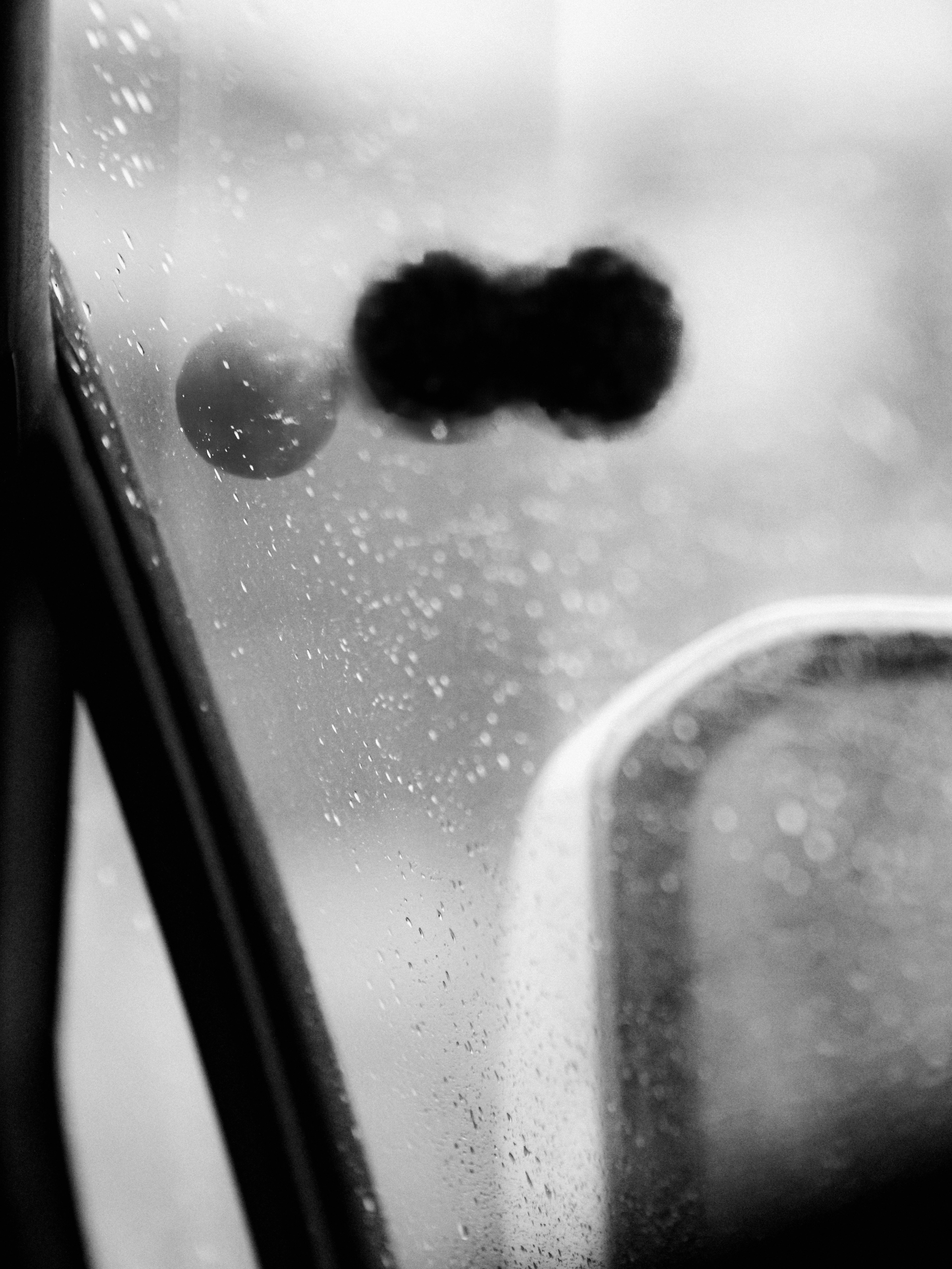 Raindrops on Glass and a Fading Reflection