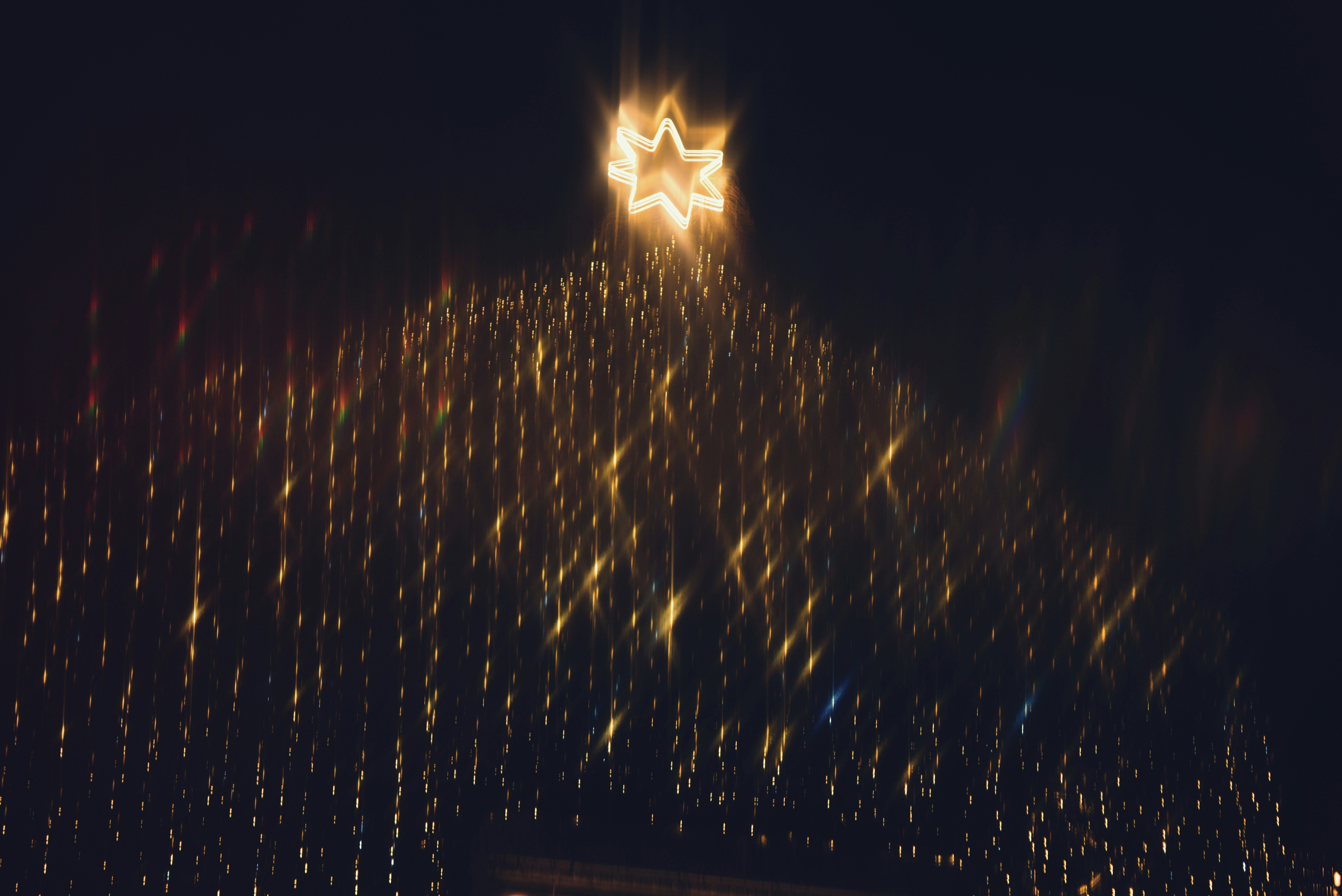 Star atop a glowing Christmas tree of cascading lights