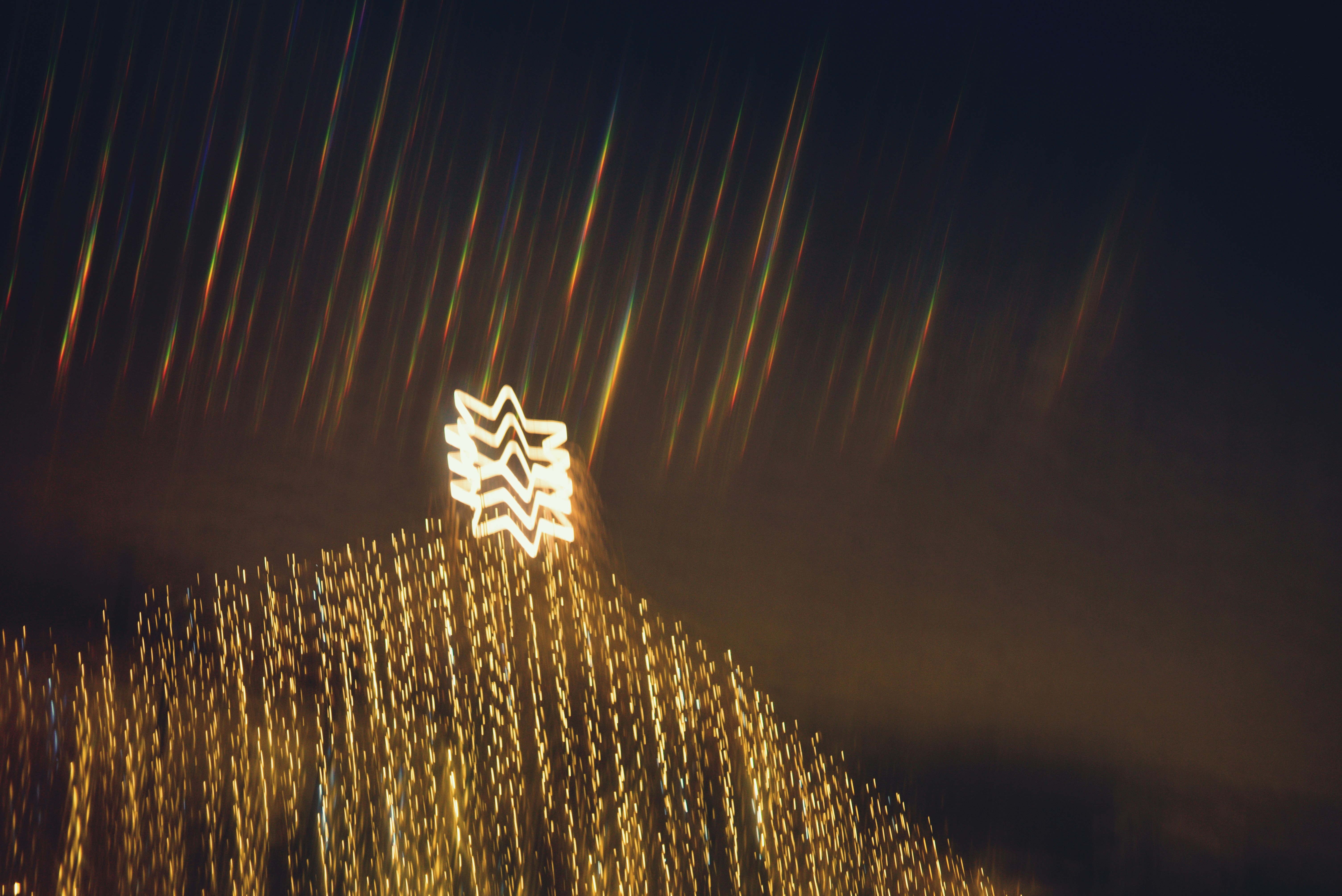 Aurora of Bokeh Trails Over a Faceted Light Sculpture