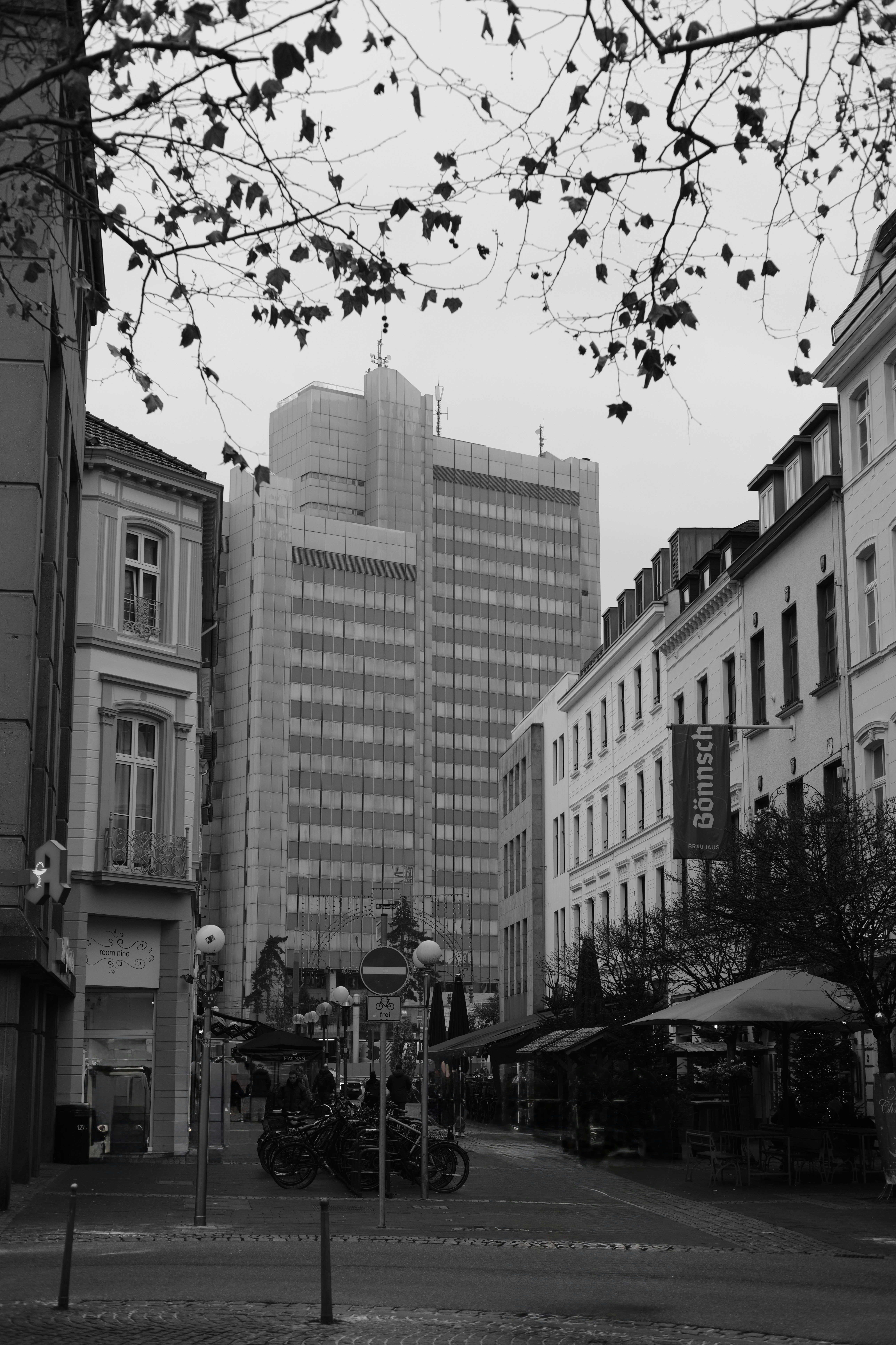 Urban Monochrome: A Narrow Street Reaches for a Skyscraper