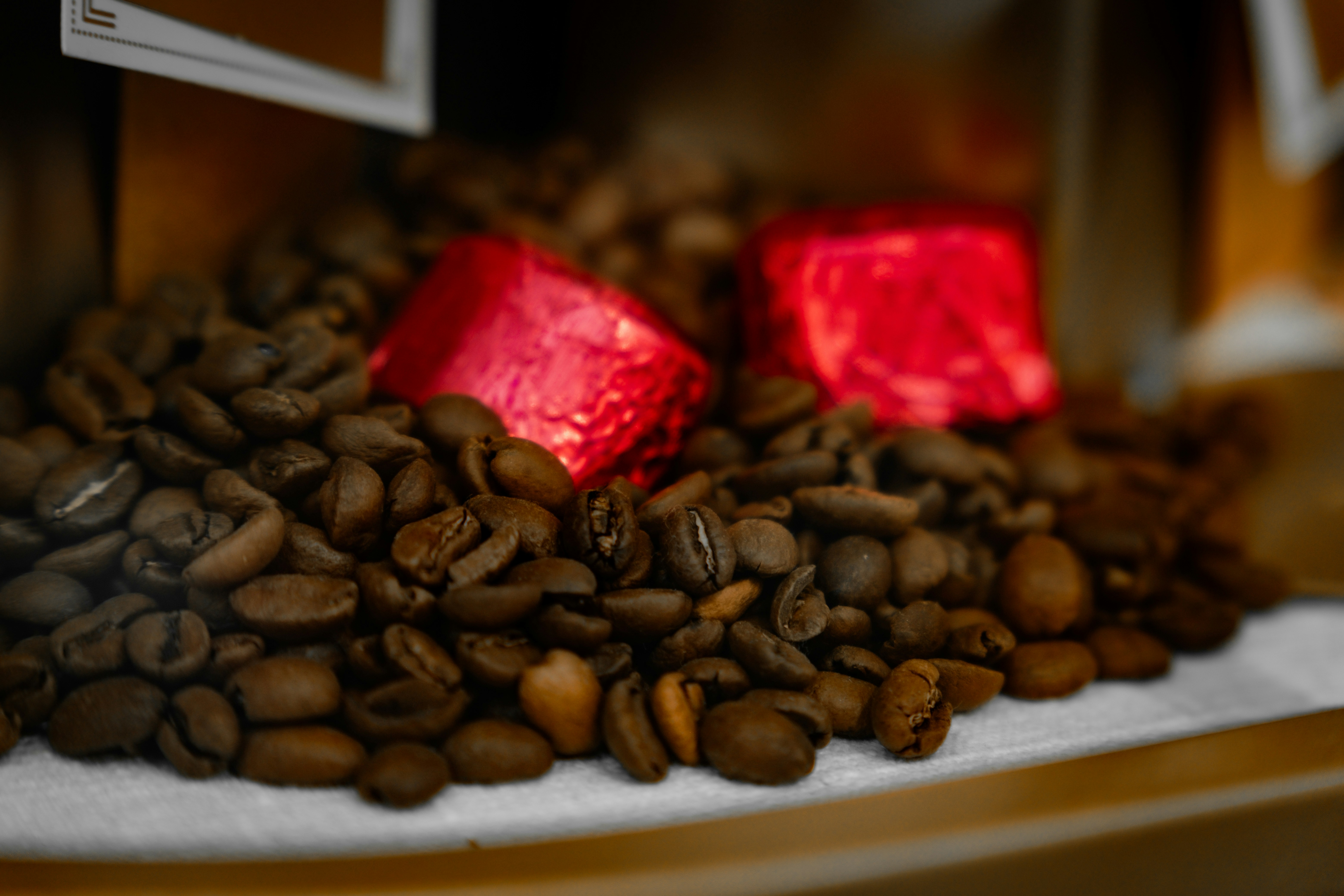 Robust Red Highlights Amid a Sea of Coffee Beans