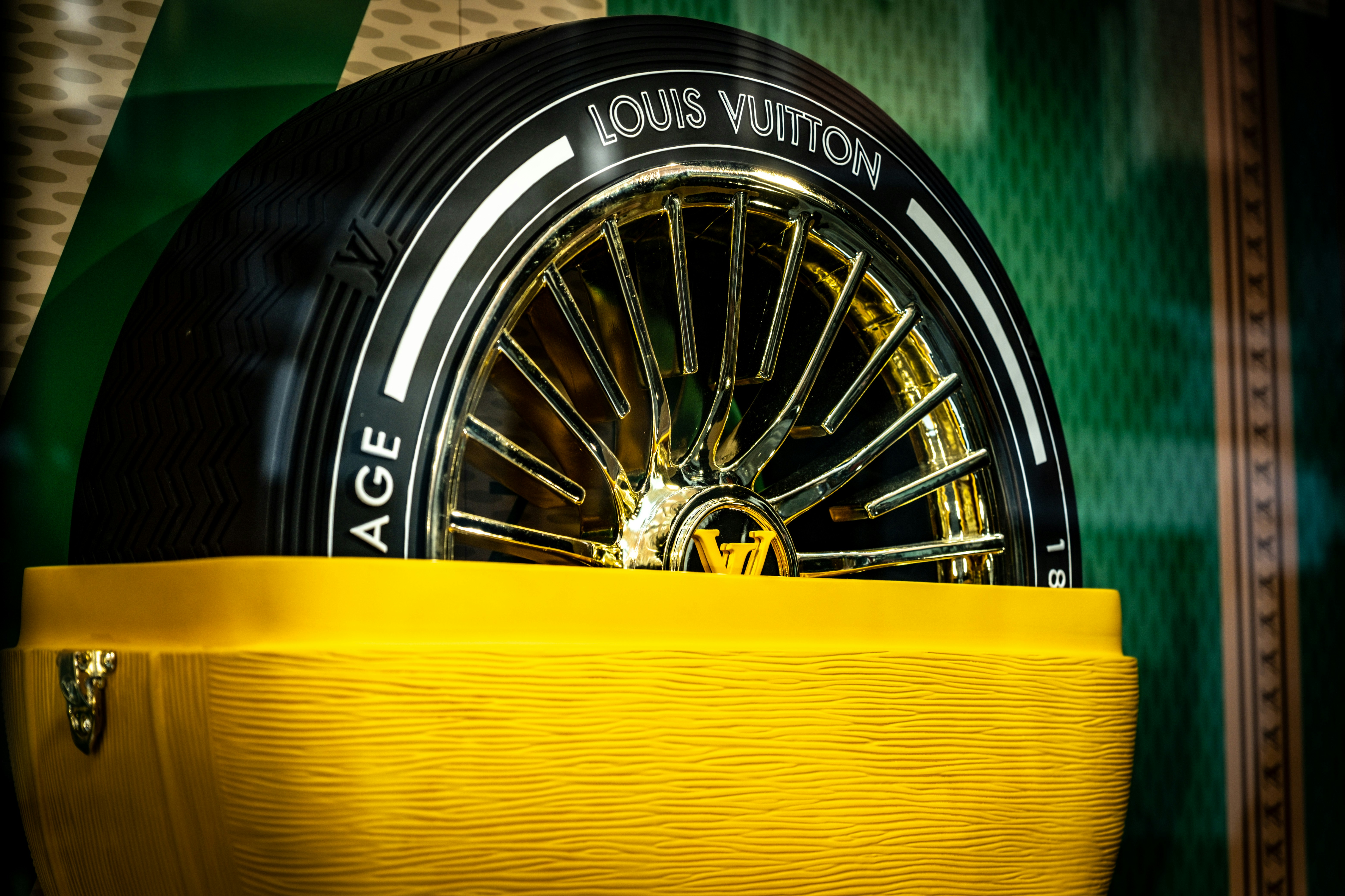 Louis Vuitton Wheel and Yellow Seating: A Luxurious Car Wheel Resting on a Gleaming Amber Seat