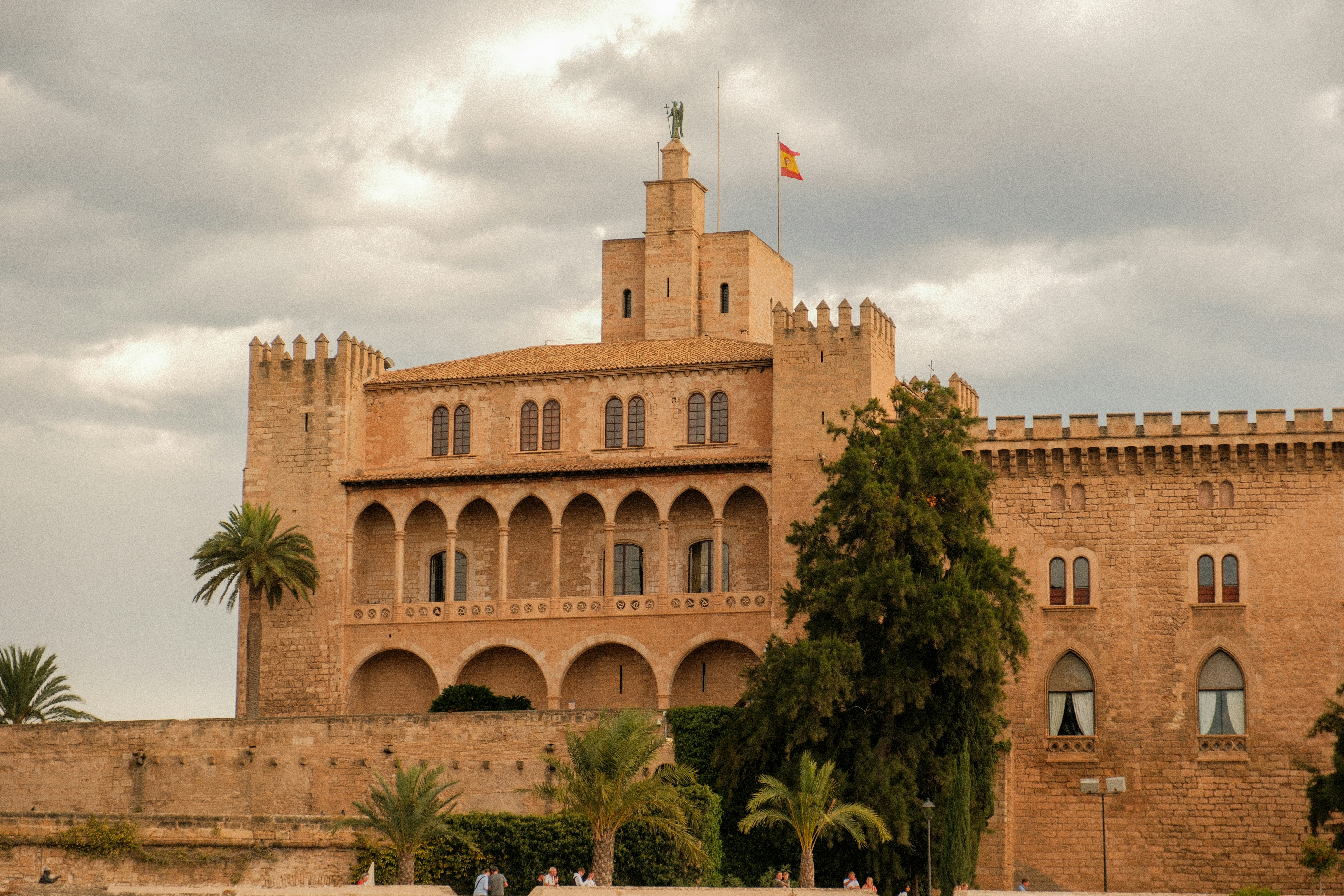 Sunlit Citadel: Golden Facade Beneath a Brooding Sky