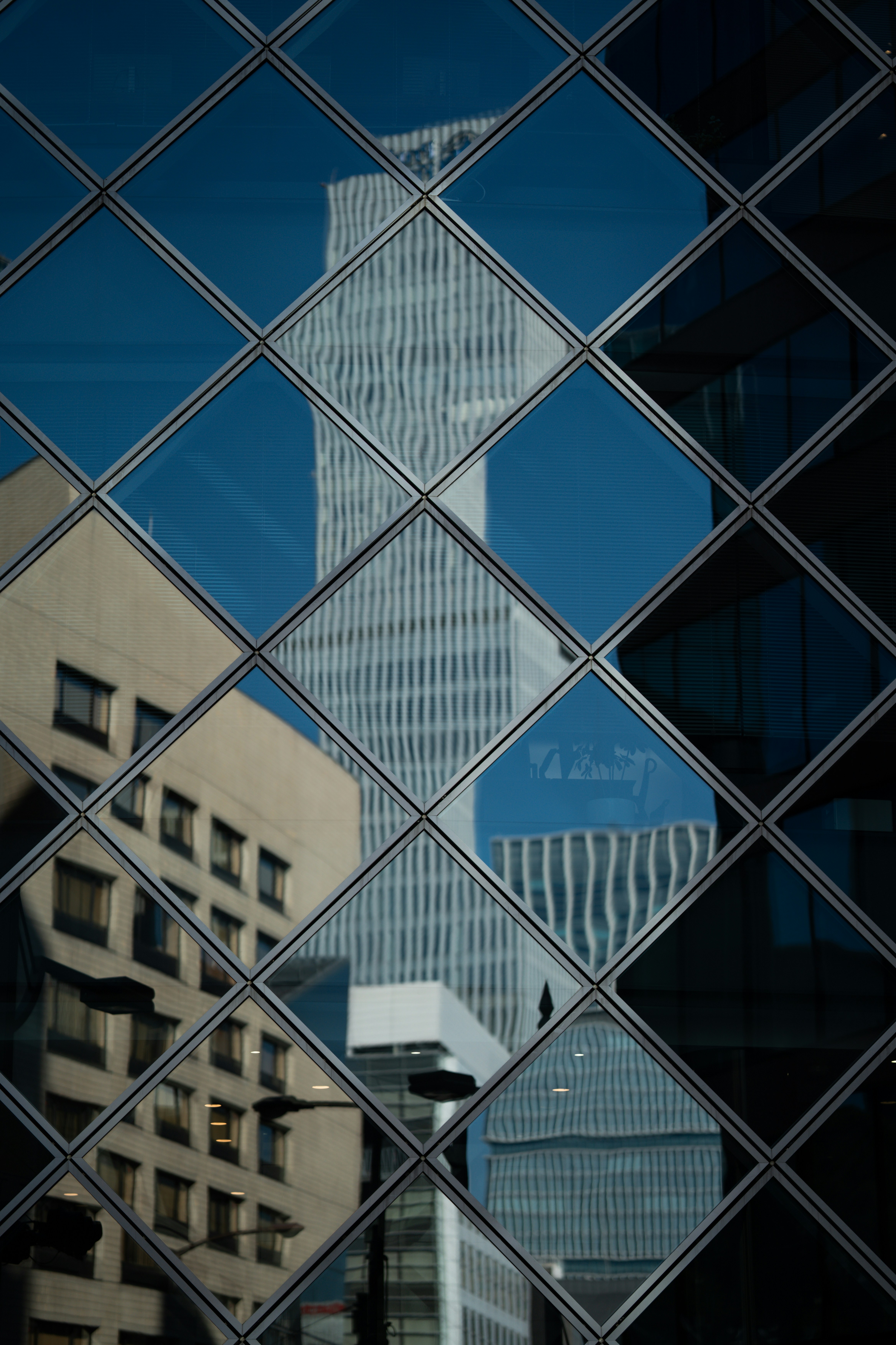 Diamond Facade: Reflections Through the Glass Grid