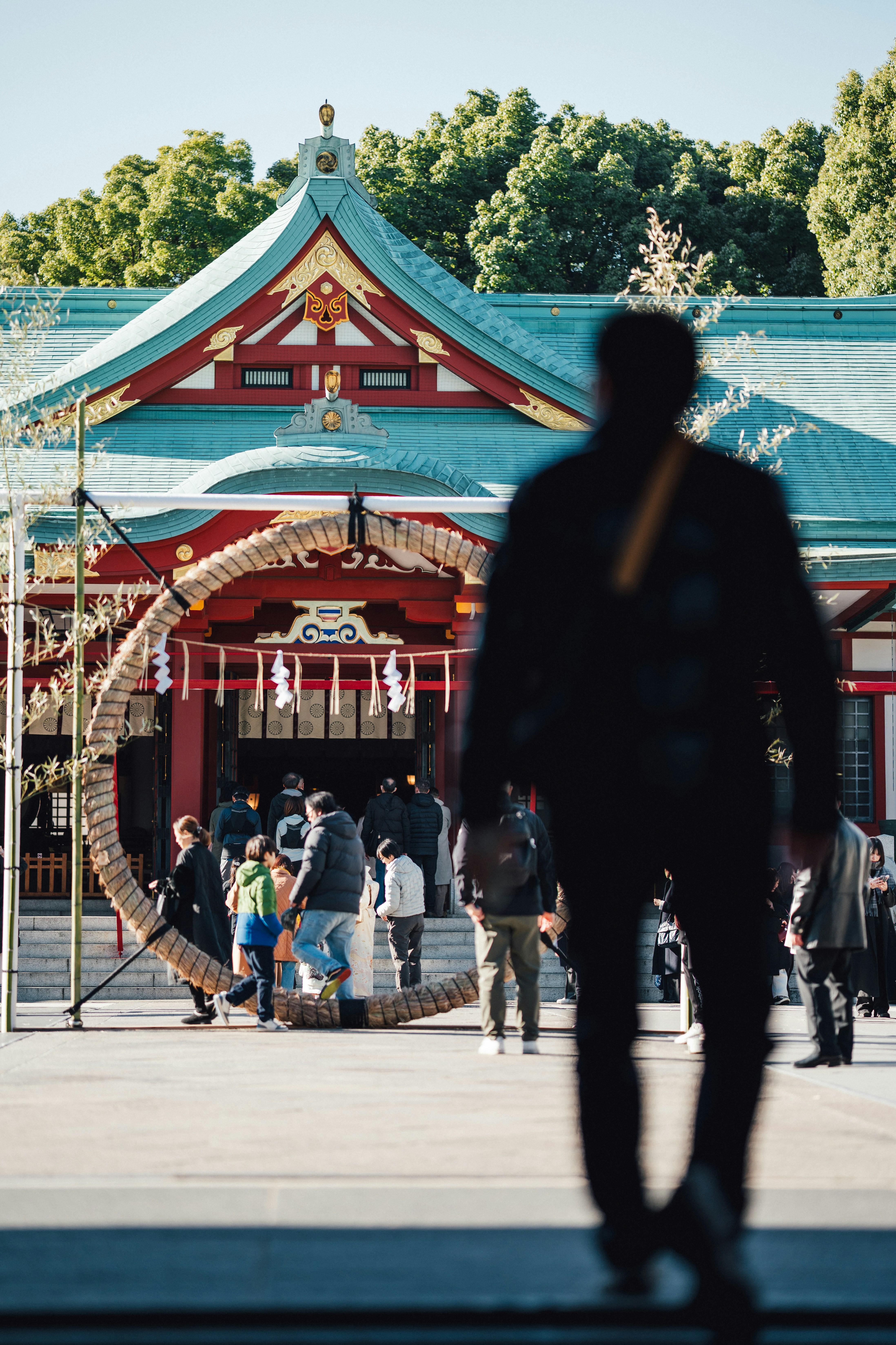 Suspended Circle at the Shrine: Visitors Enter the Sacred Gate