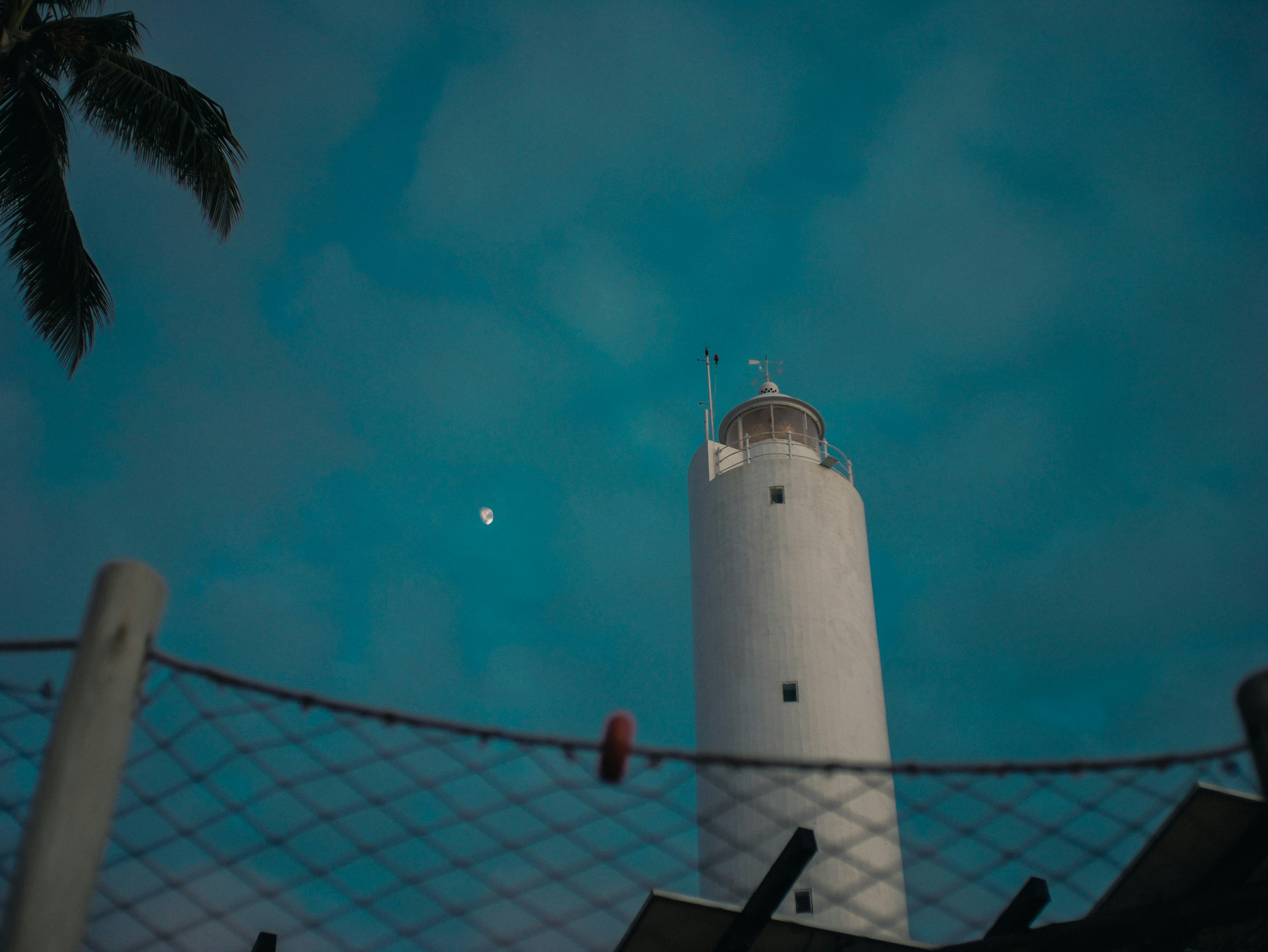 Lighthouse Over Blue Sky: A Quiet Coastal Moment
