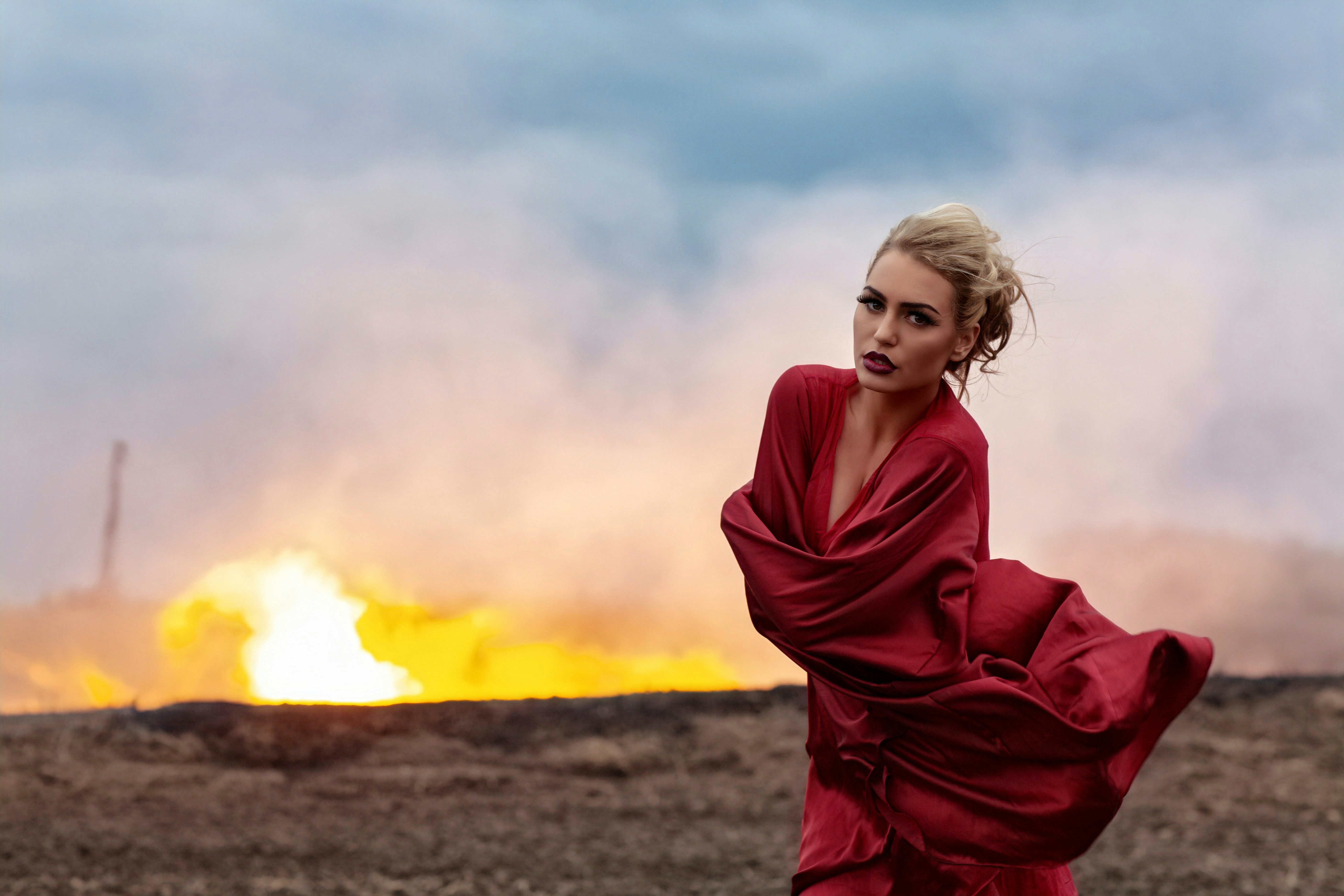 Red cloth, red horizon: a lone figure against fire-lit ground