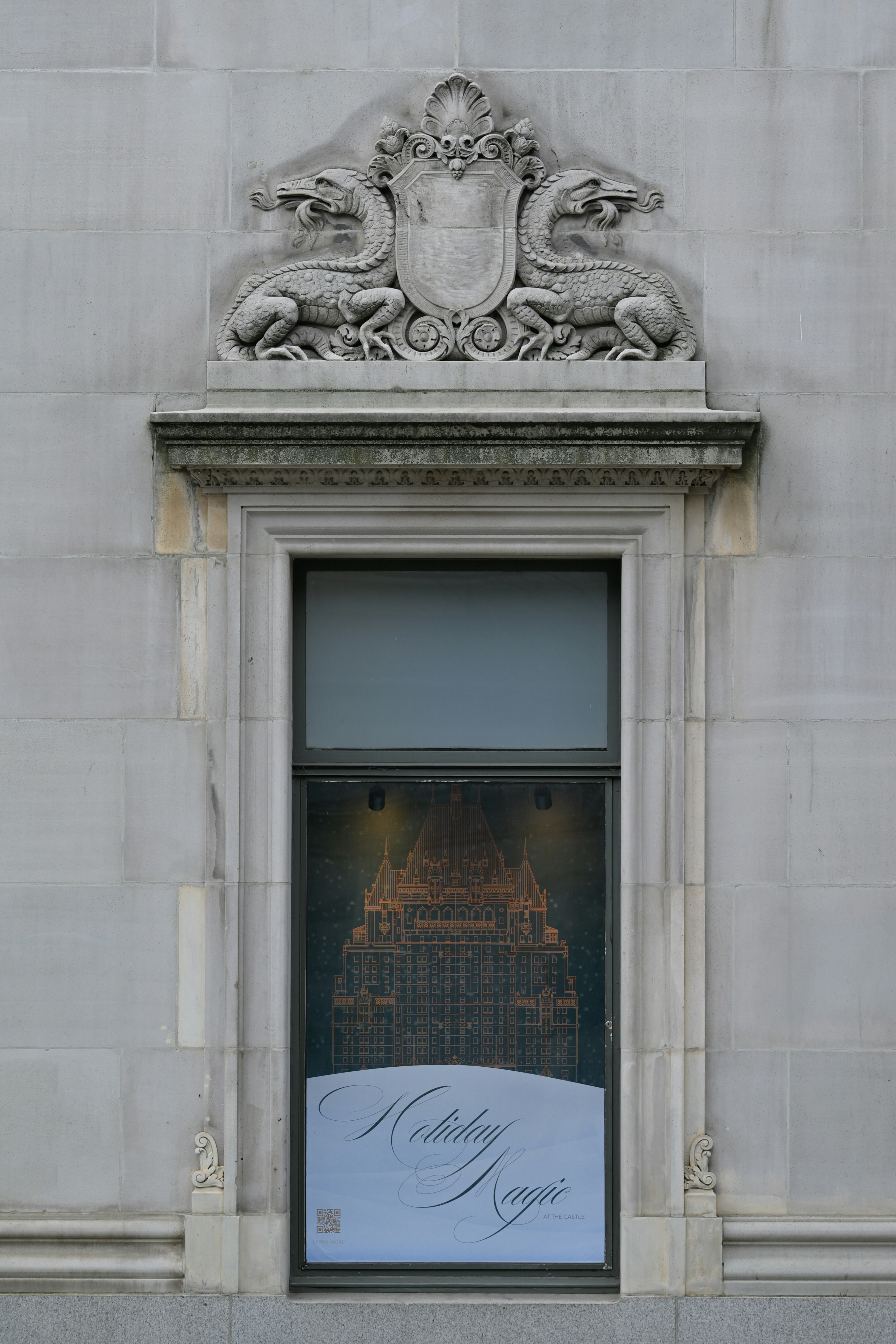 Ornate Crest Above a Windowsill with Subtle Advertising Panel