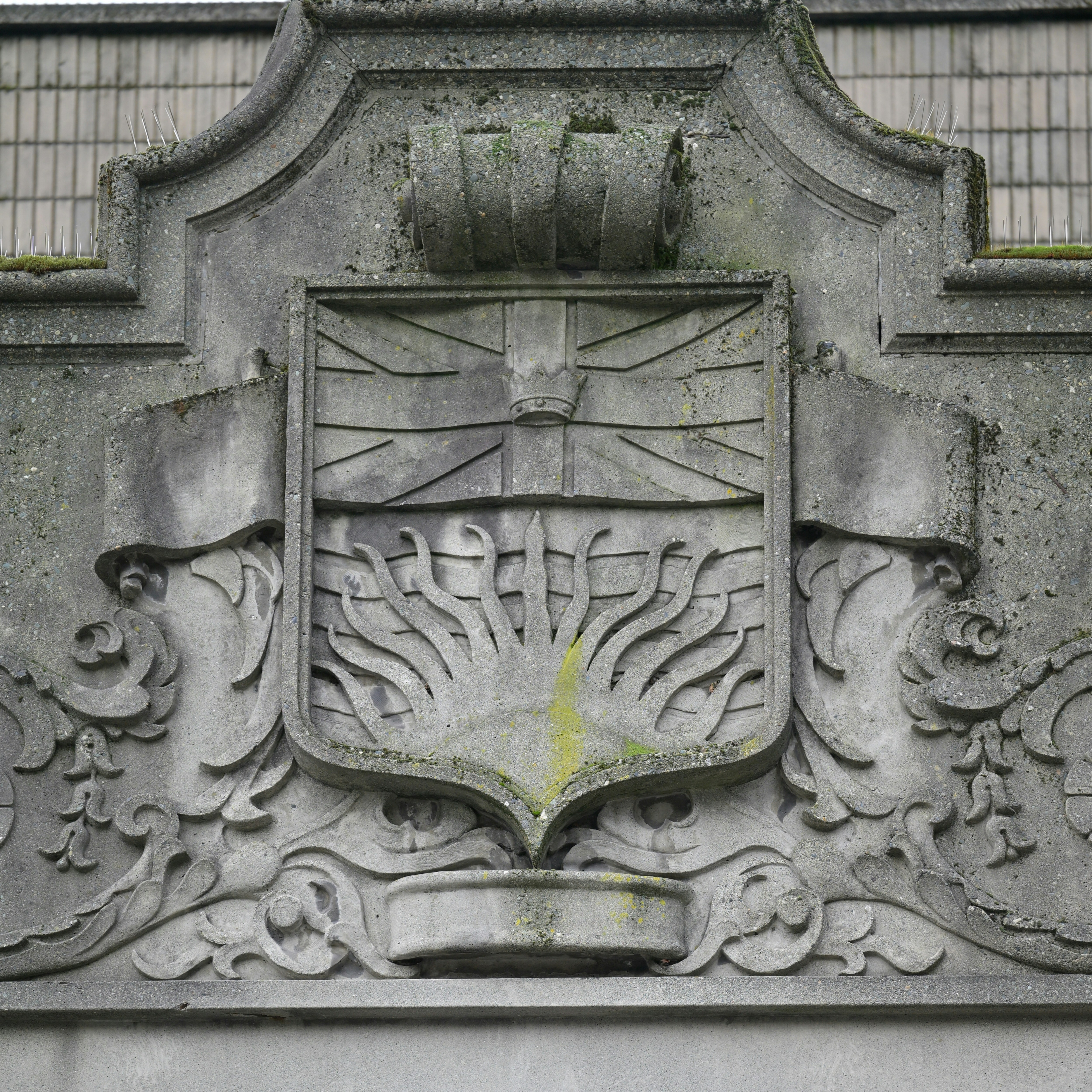 Stone Coat of Arms: Carved Emblem amid Ornate Relief